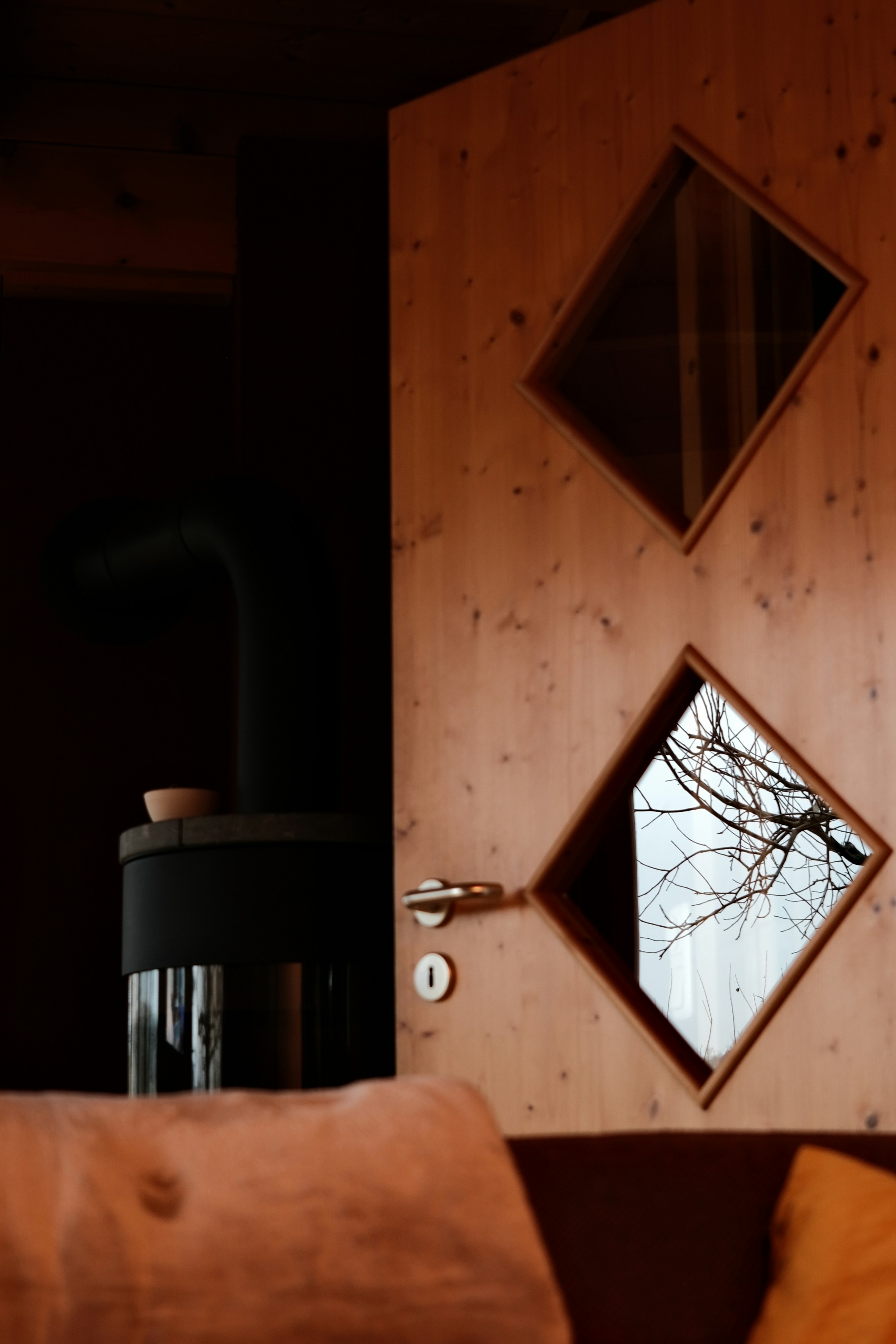 Warm Wooden Doorway with Diamond Windows Reflected in Frosted Glass