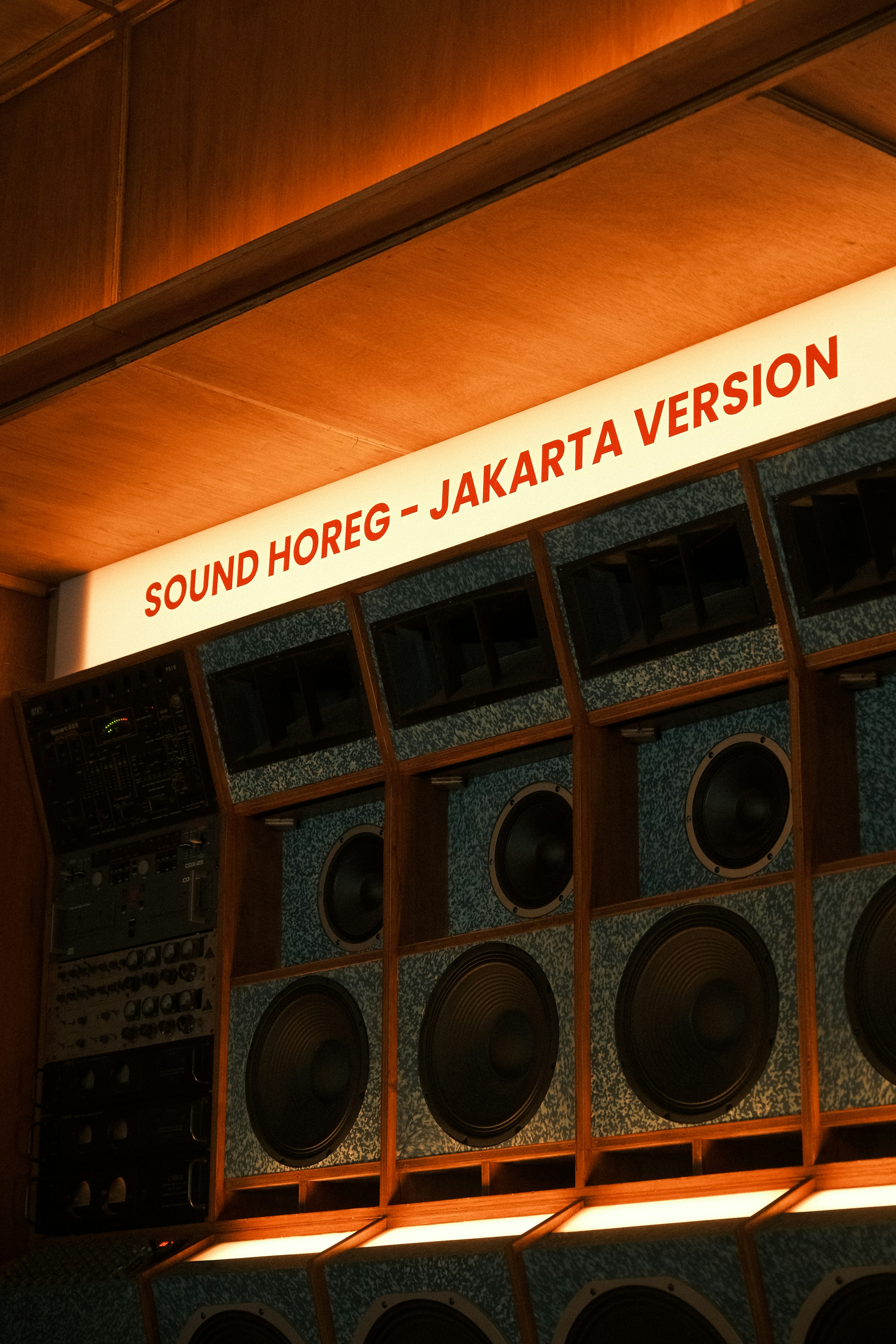 A vintage sound system titled "Sound Horeg – Jakarta Version" featuring large speakers and audio equipment. The retro design and warm lighting create an inviting atmosphere for music enthusiasts in Jakarta.