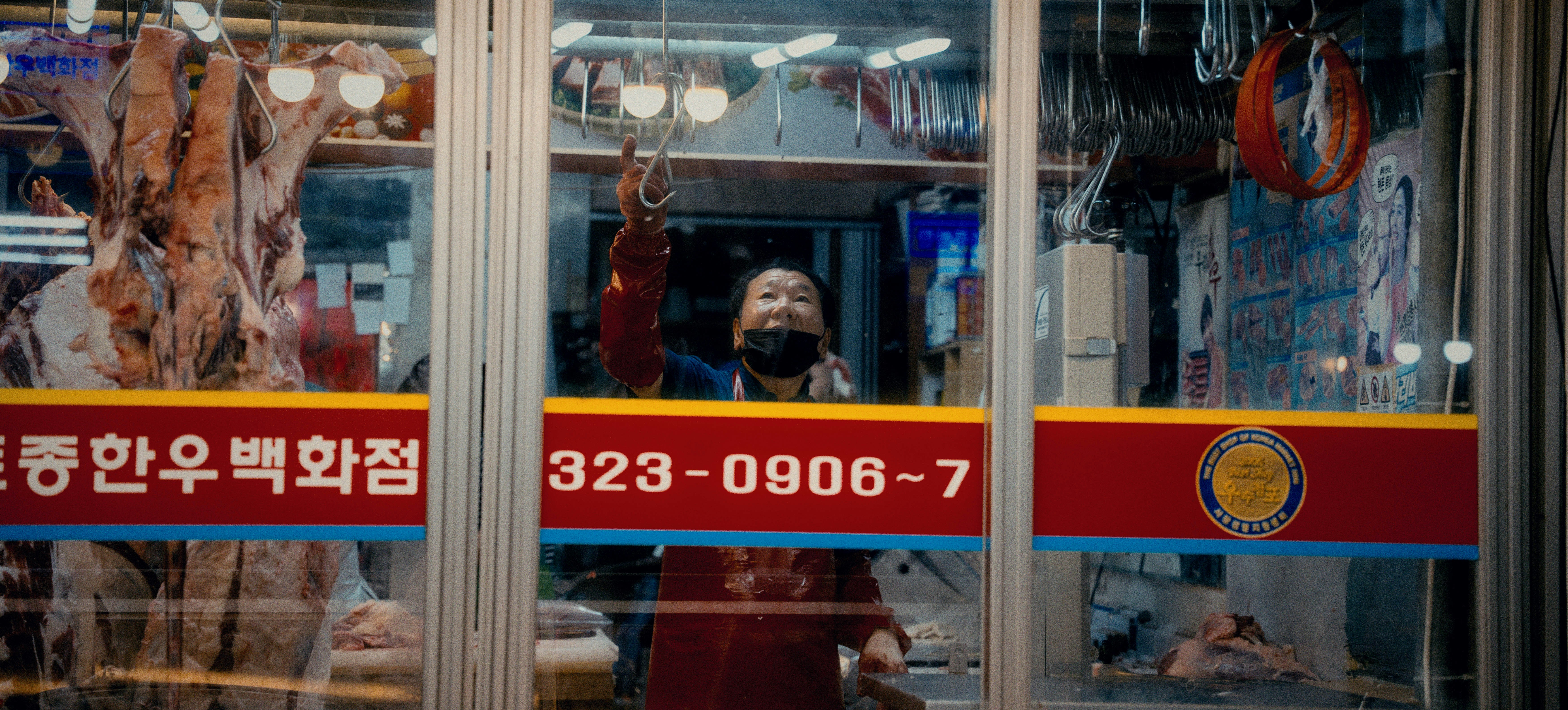 Market Butcher in Glass: Reflections and Red Stripe