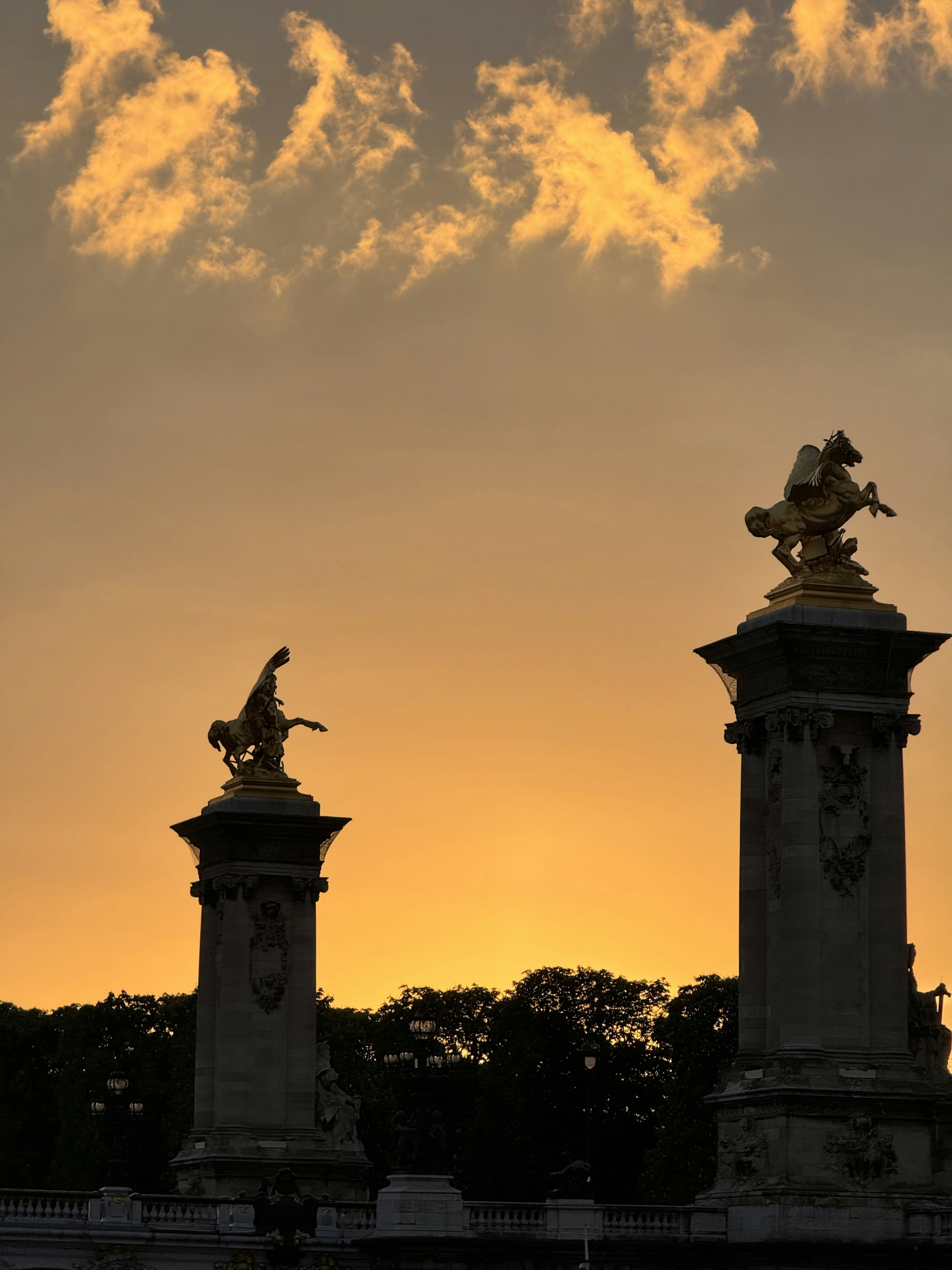 Silhouetted Guardians at Sunset