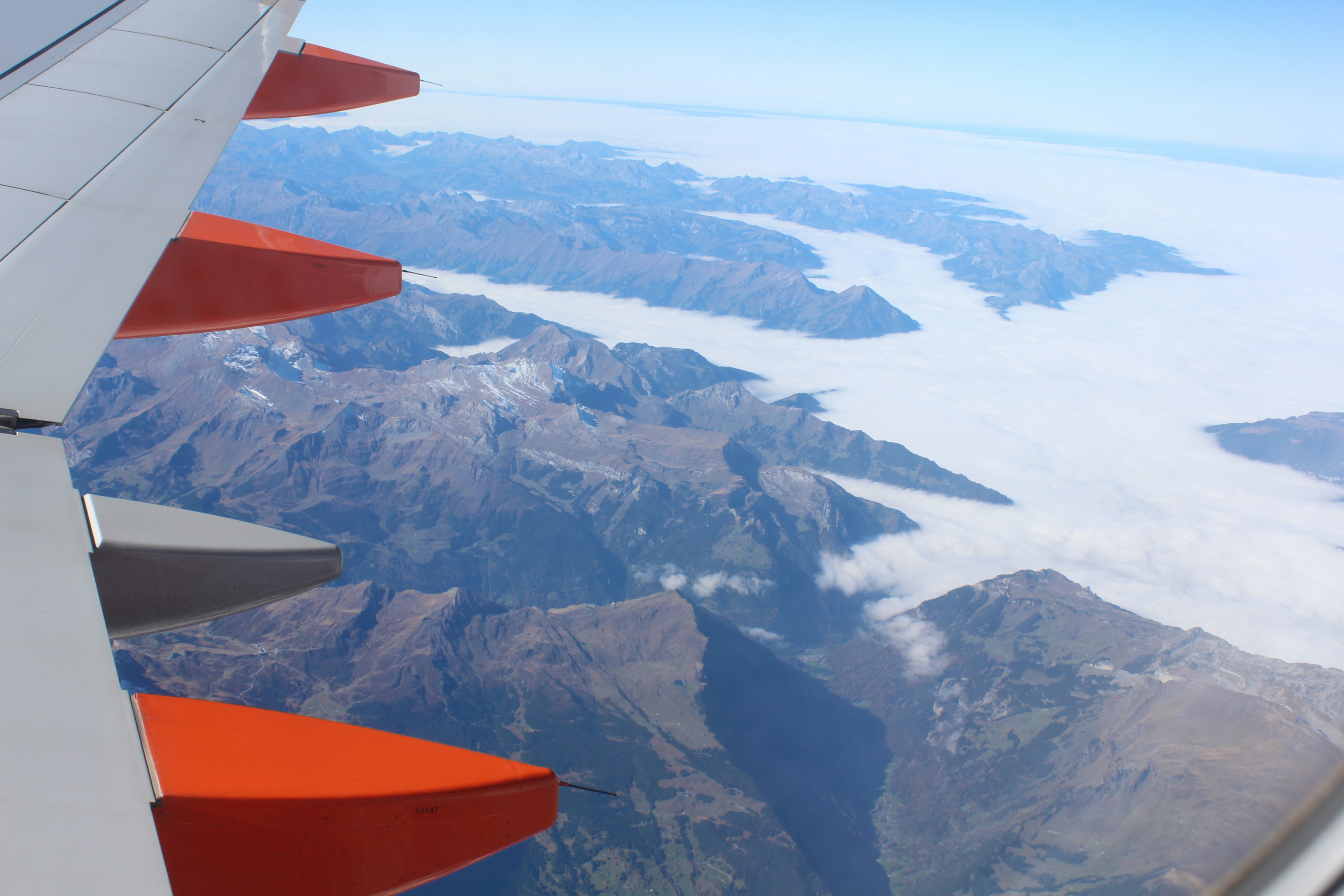 Winglets Over Rugged Peaks: A Skyward Window into the Alps