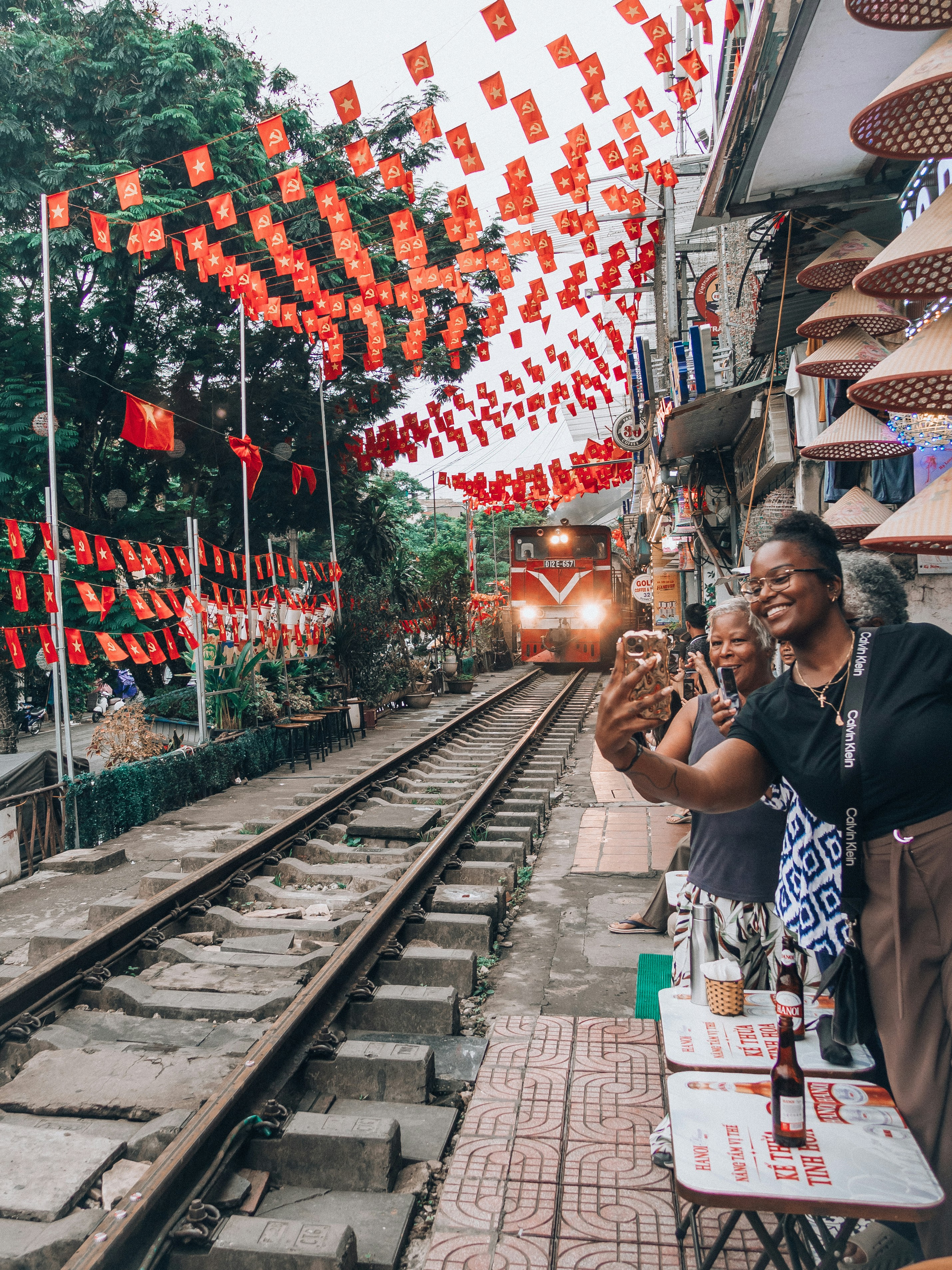 Railway selfie under a sea of red flags and a waiting locomotive