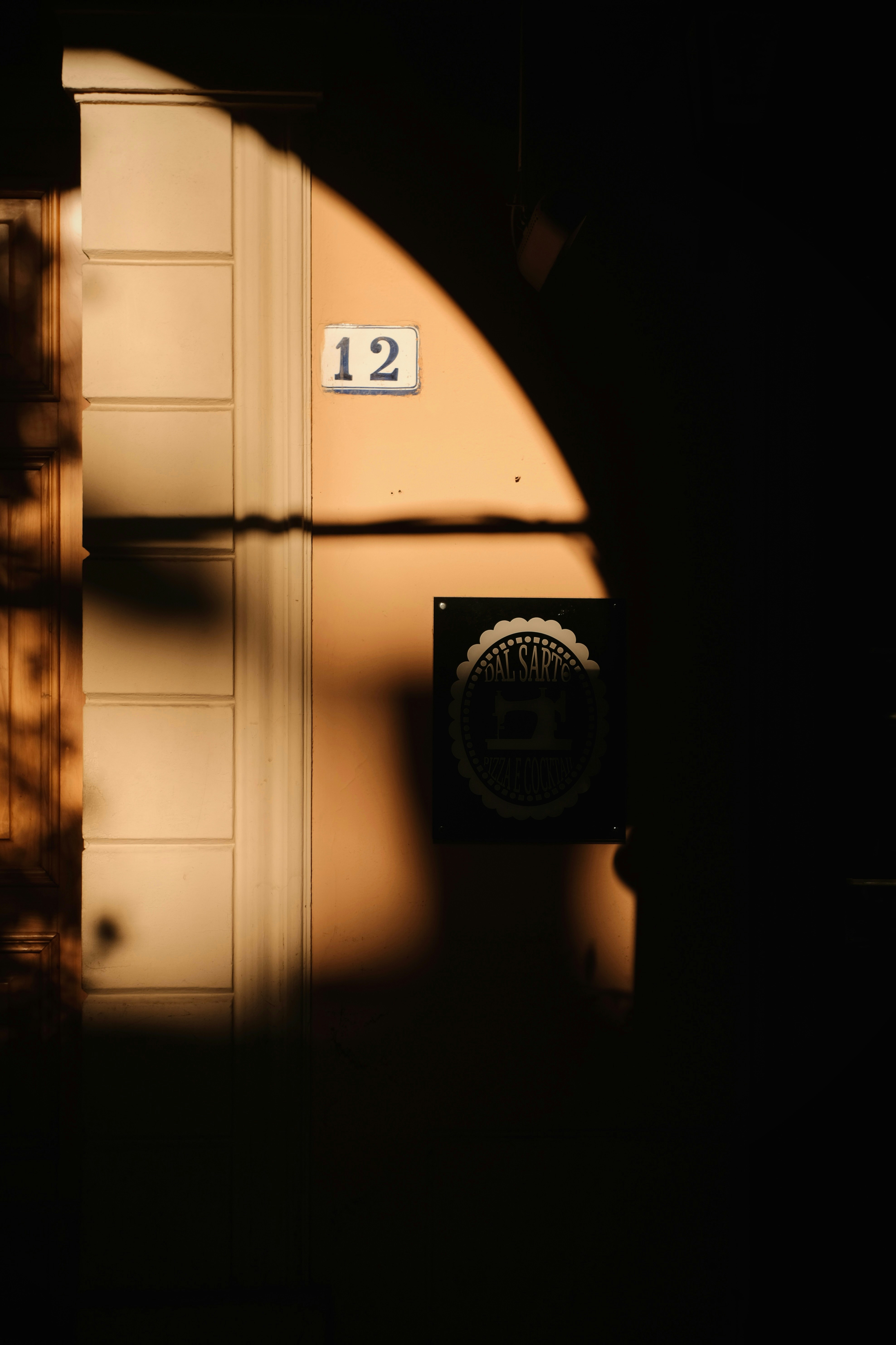 Shadowed Doorway: Sunlit Circle Over a Bronzed Threshold
