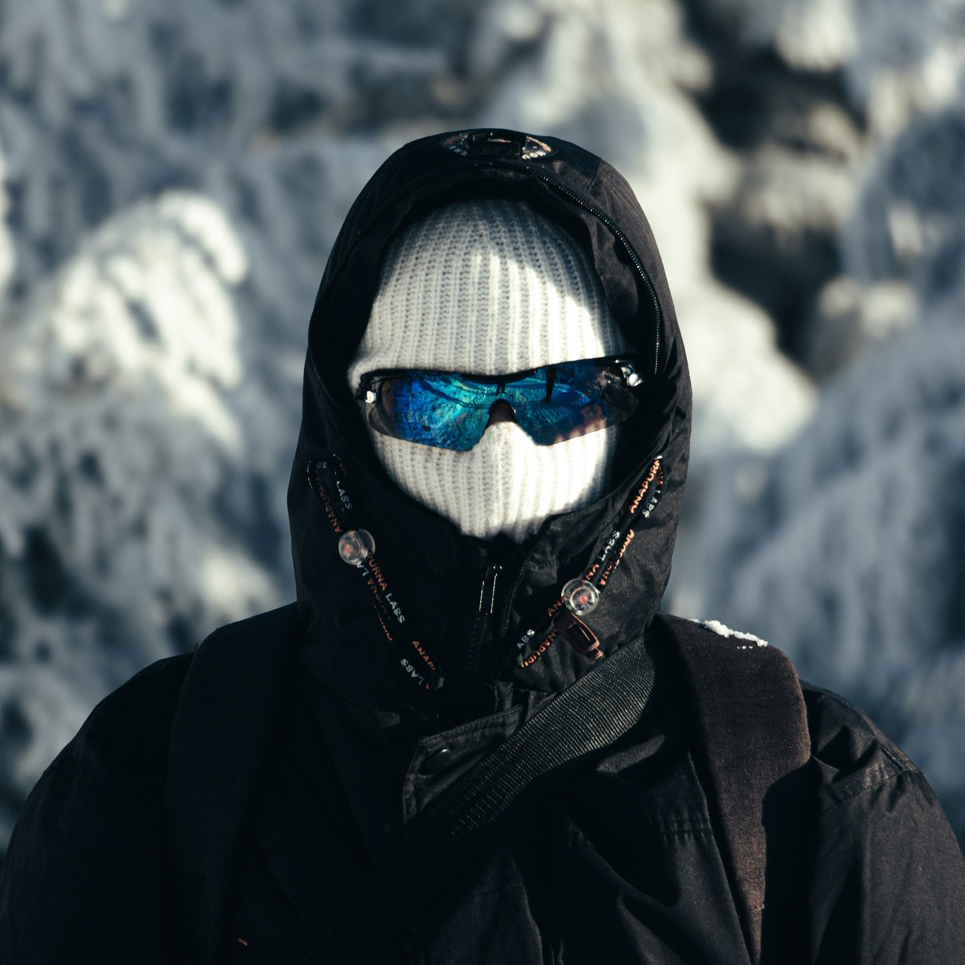 Hidden Face in the Snow: Snowboarder in Black Arctic Gear