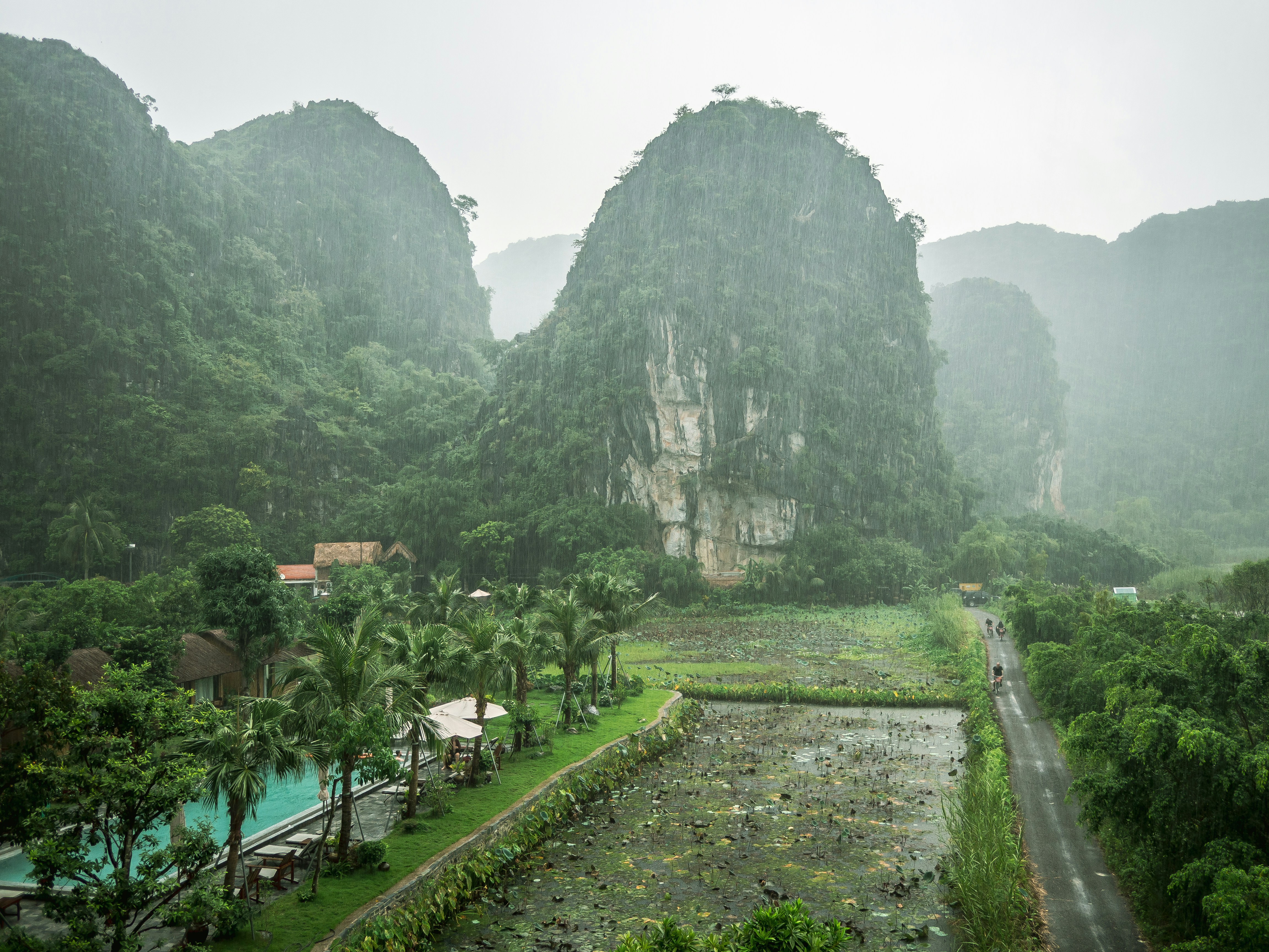 Limestone Cliffs Veiled by Mist Over a Lush River Valley