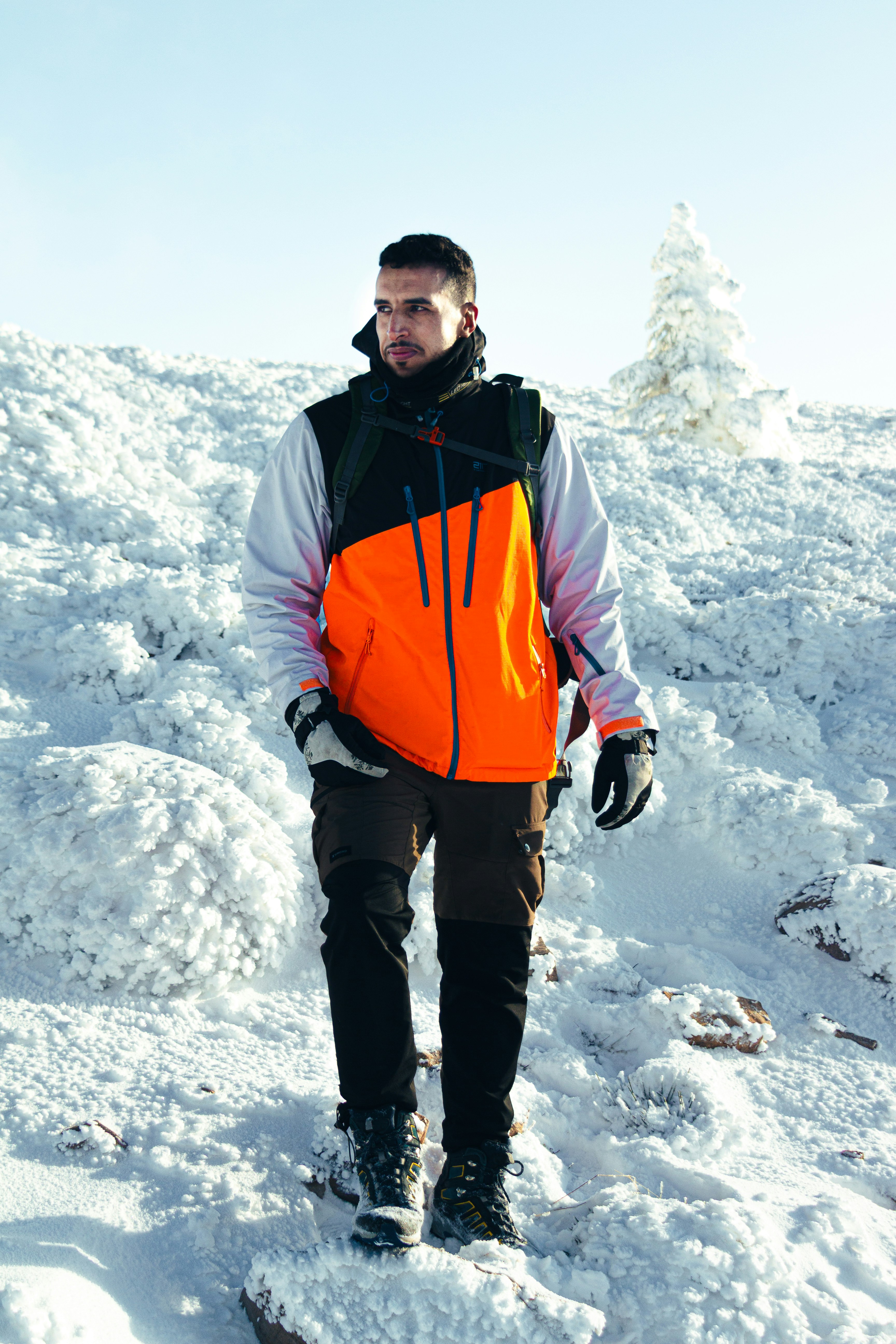 Brightly Coloured Explorer Amid Snowbound Ridge