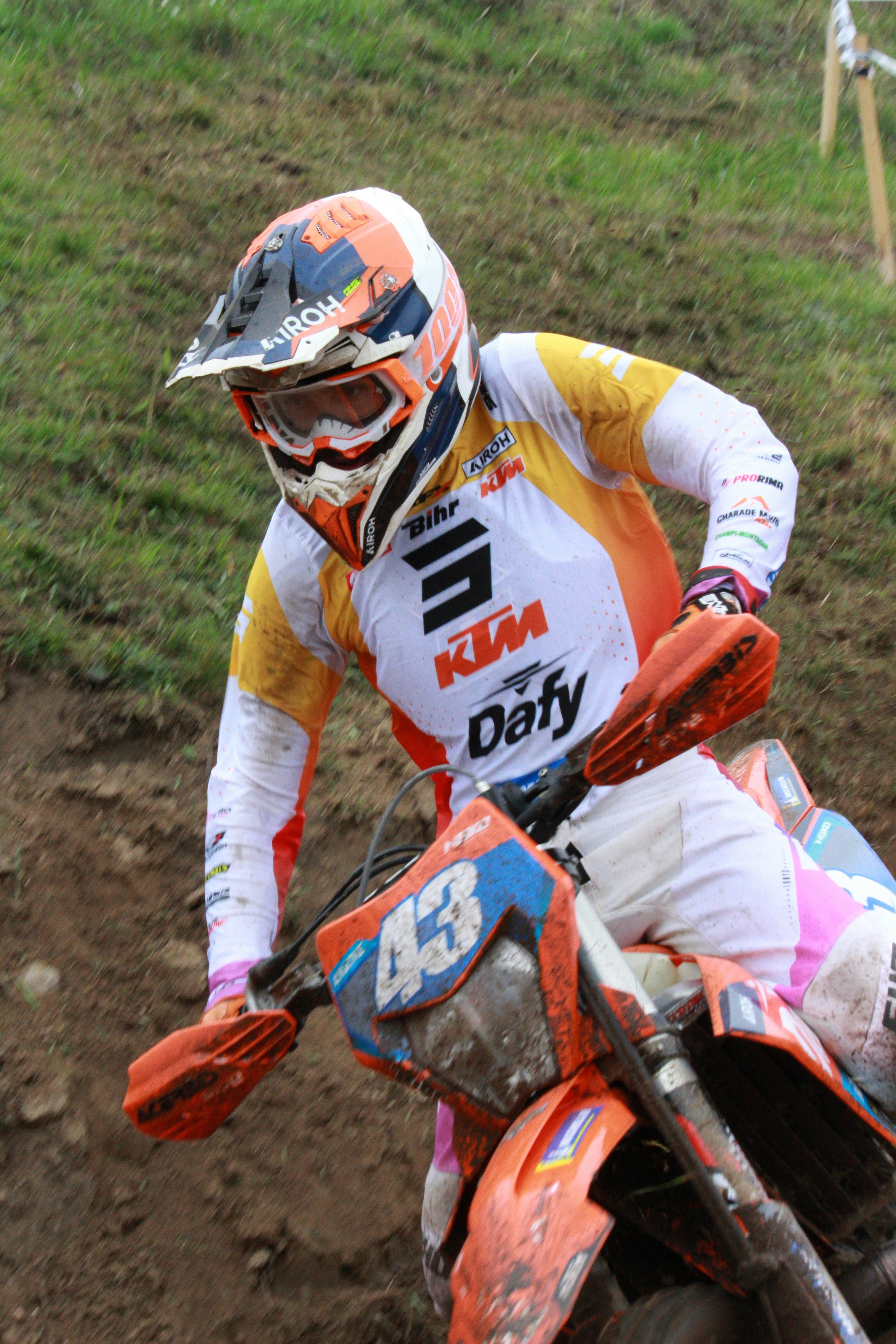 Rider in Motion: Orange-White KTM on a Dirt Track