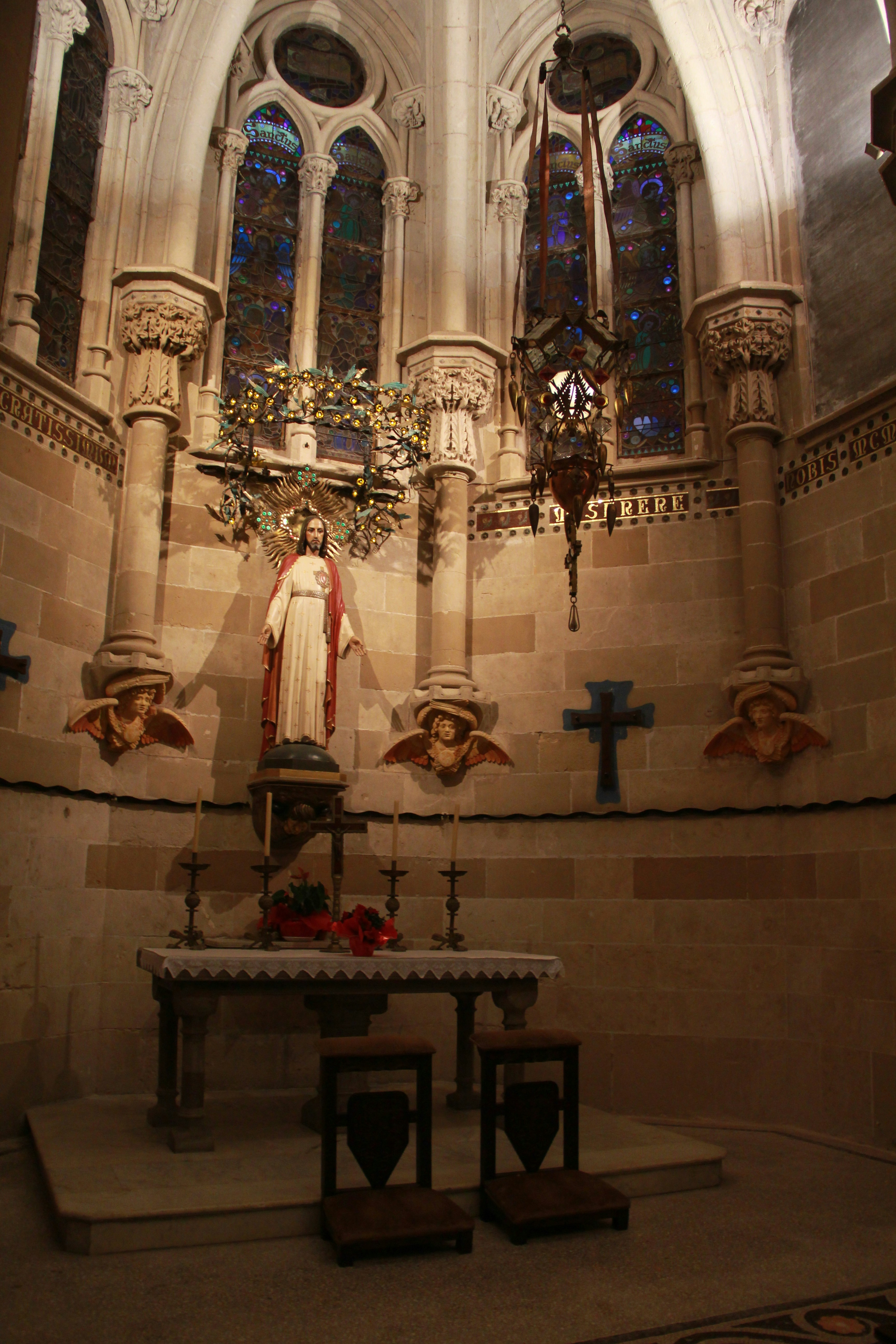 Altar of Reverence: Christ in Stained Light Amid Gothic Archways