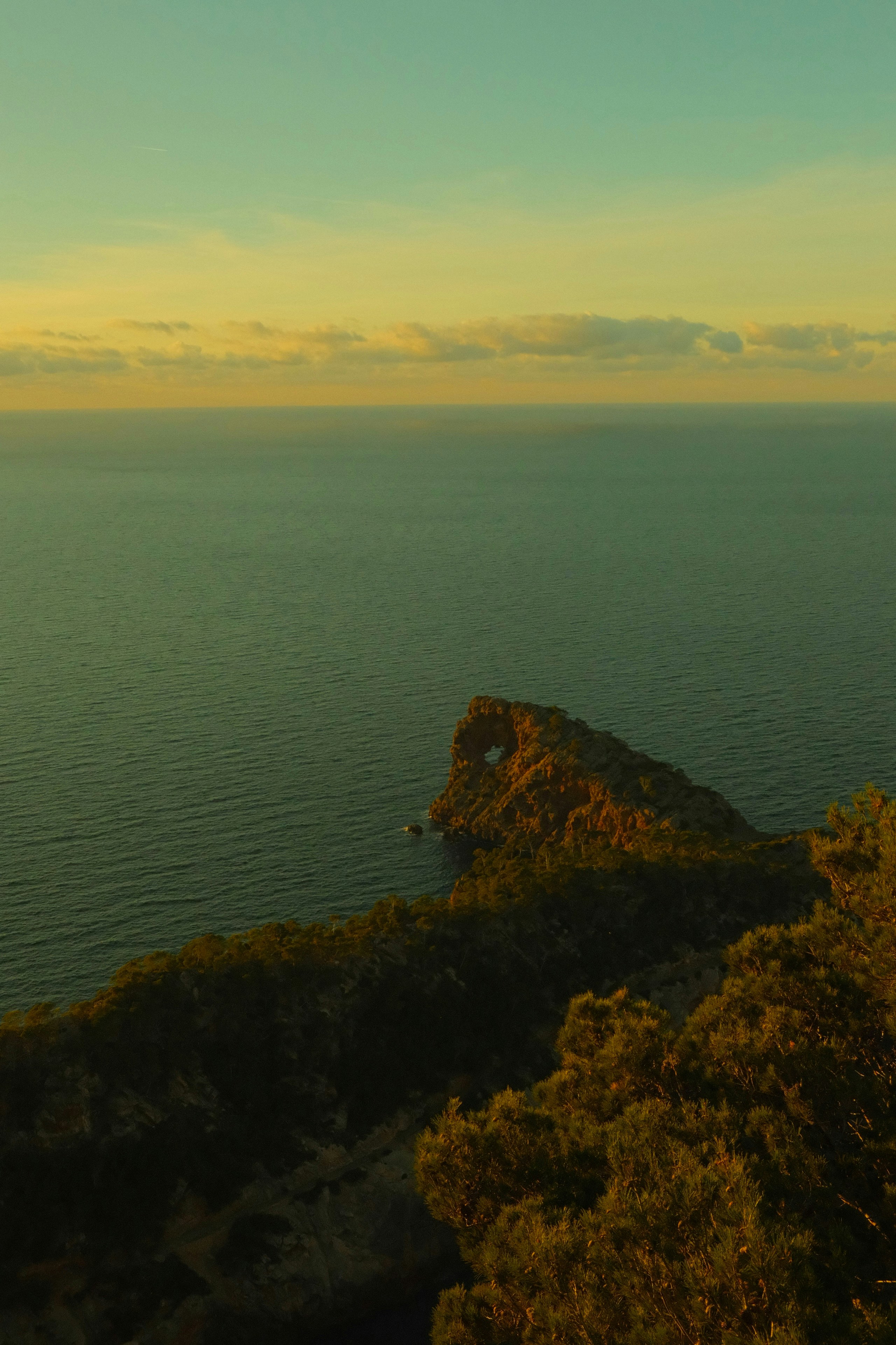 Coastal Crest at Dusk: A Quiet Promontory Over the Sea