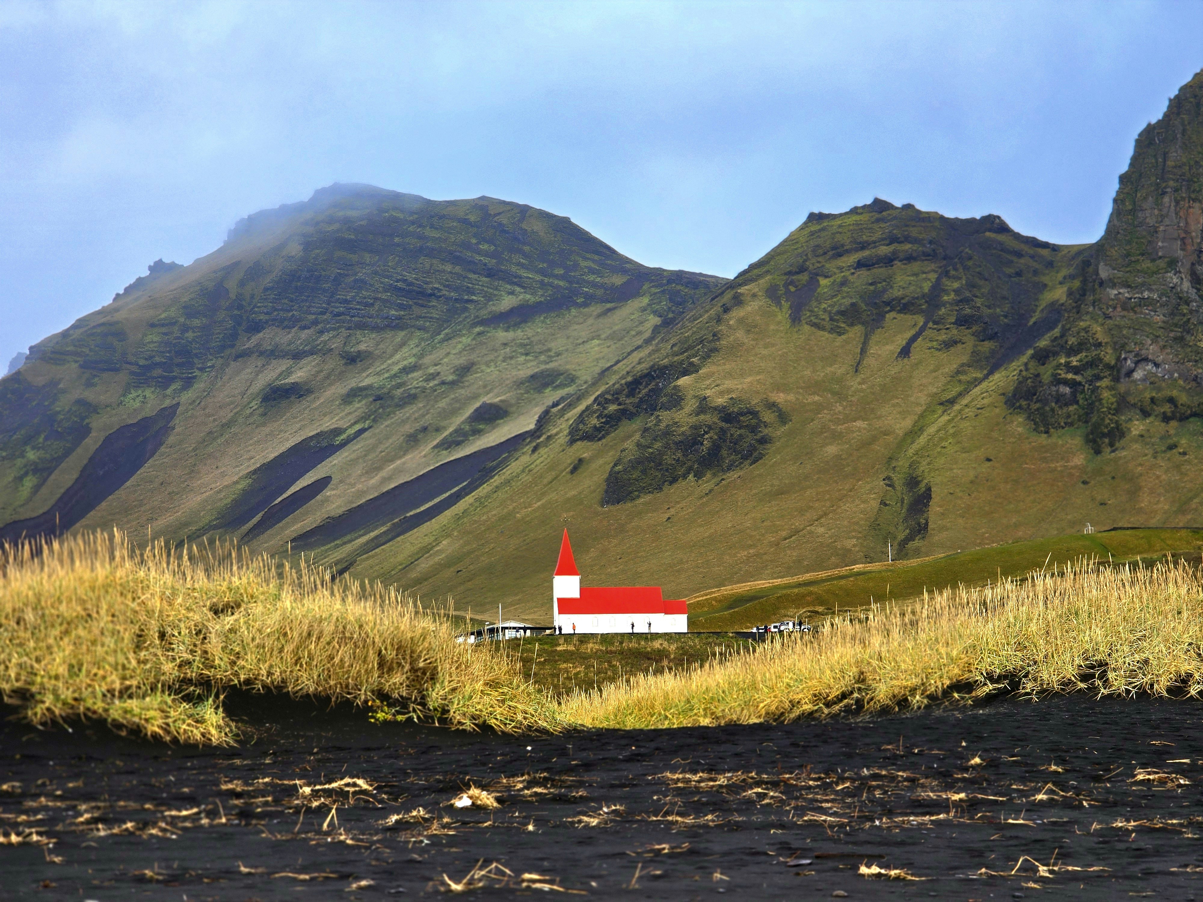Red-roofed Church Nestled in a Mountain Bowl