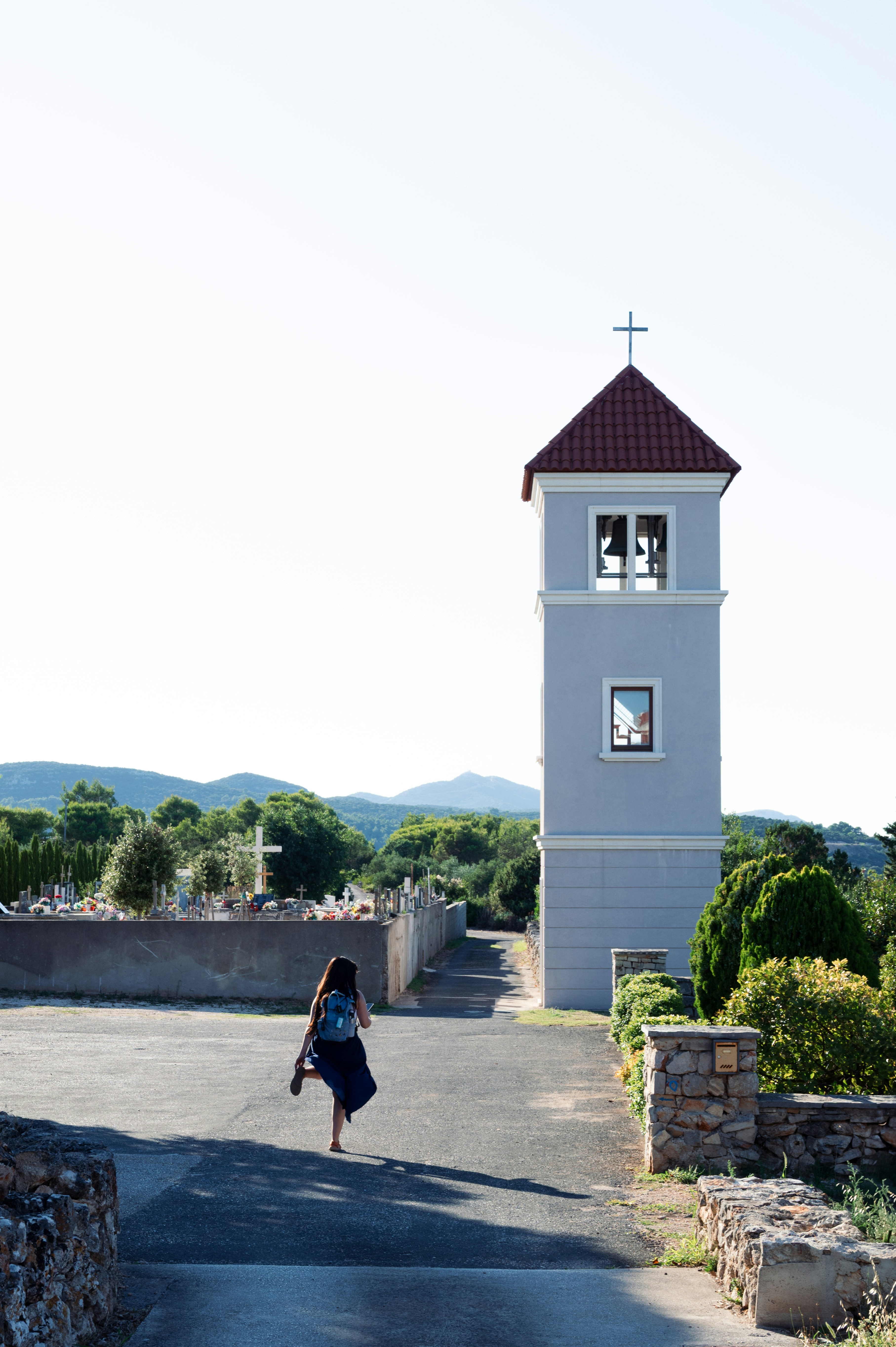 Steepled Silence: A Visitor Approaches the Bell Tower