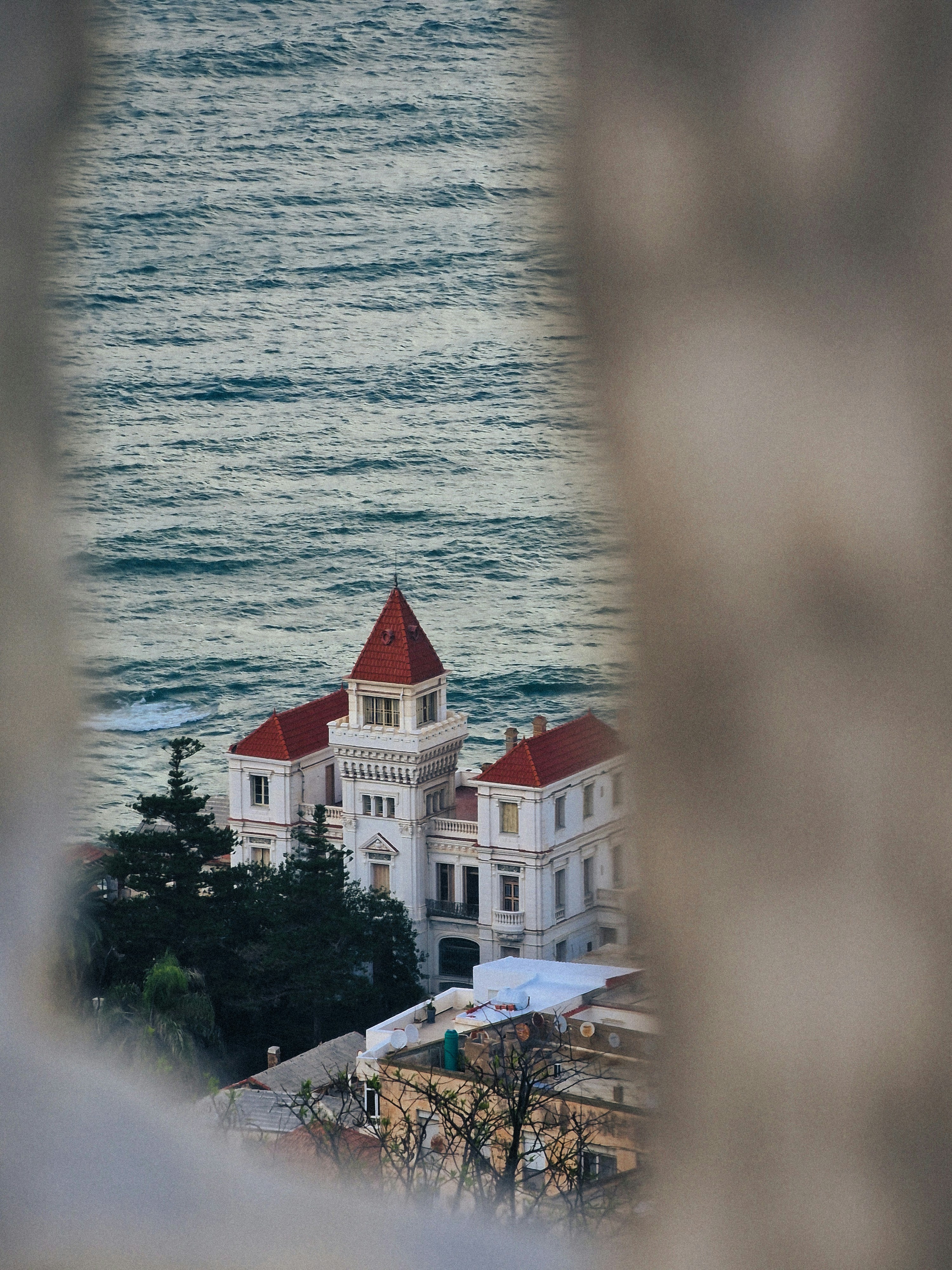 Hidden Chateau by the Sea: A Terrace View Framed Between Stone Arches
