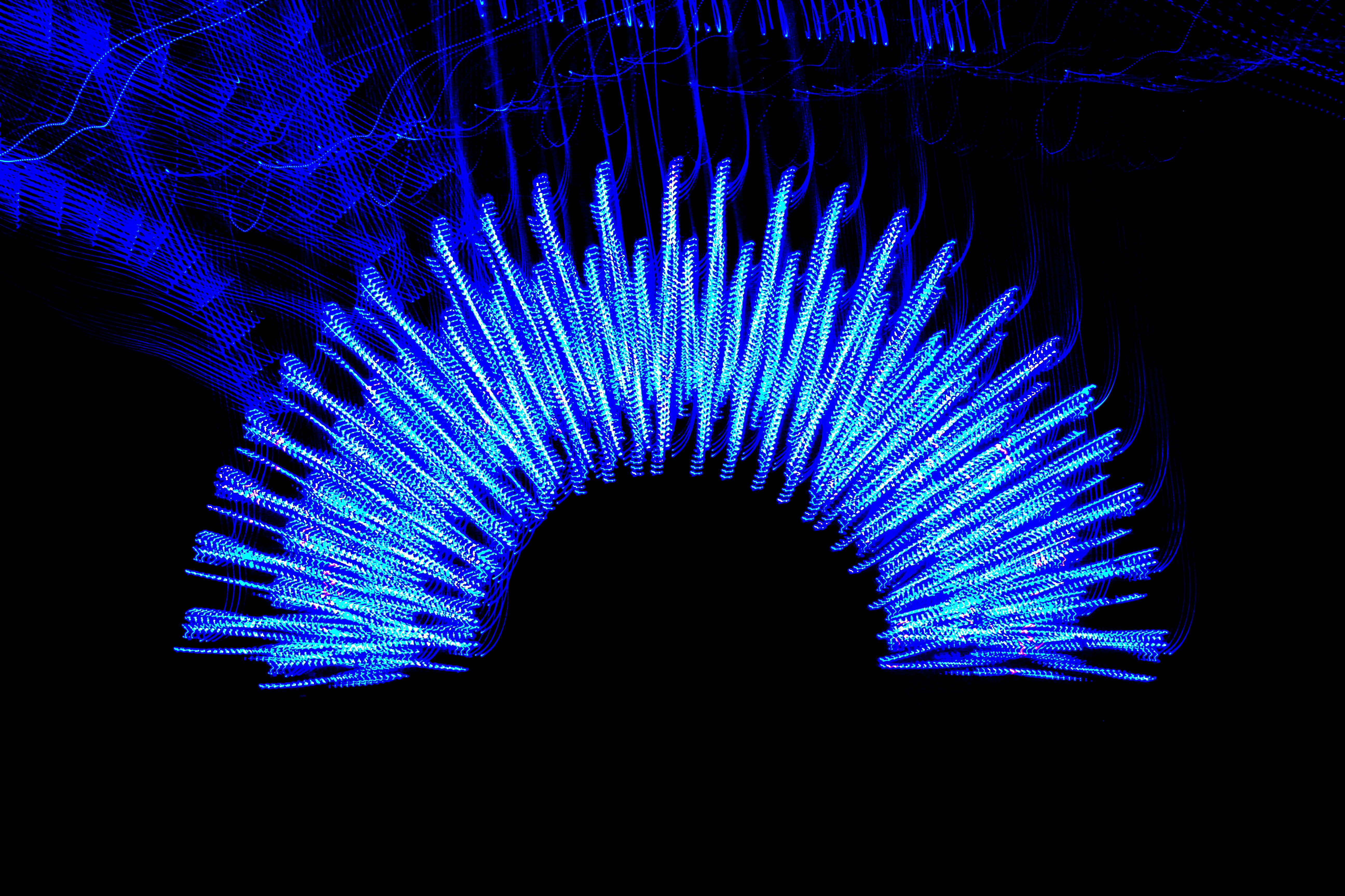 Electric Blue Arc: Neon Spokes Weaving Through Darkness