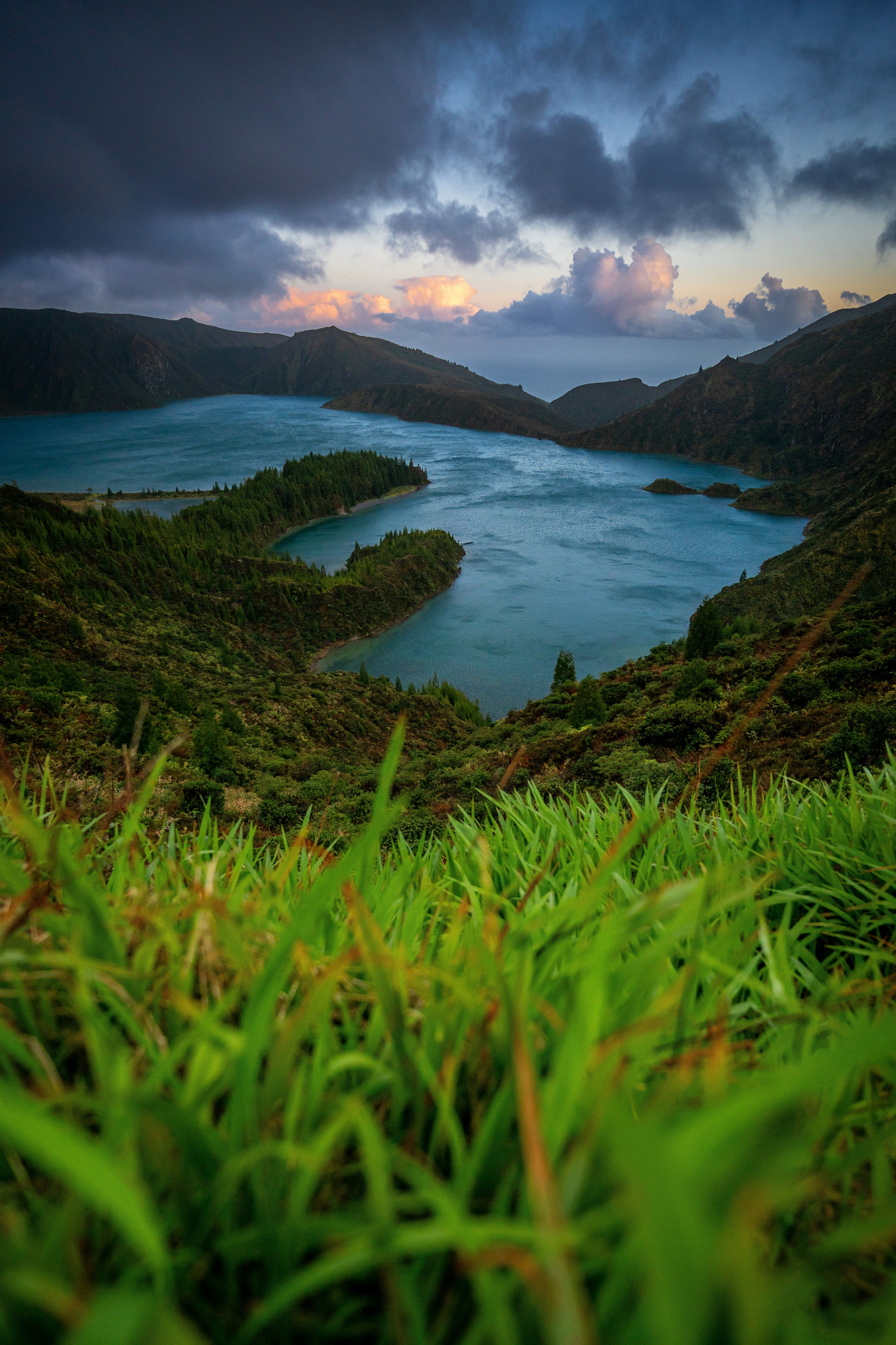 Emerald Inlet: A V-shaped Lake Surrounded by Rolling Green Cliffs at Dusk