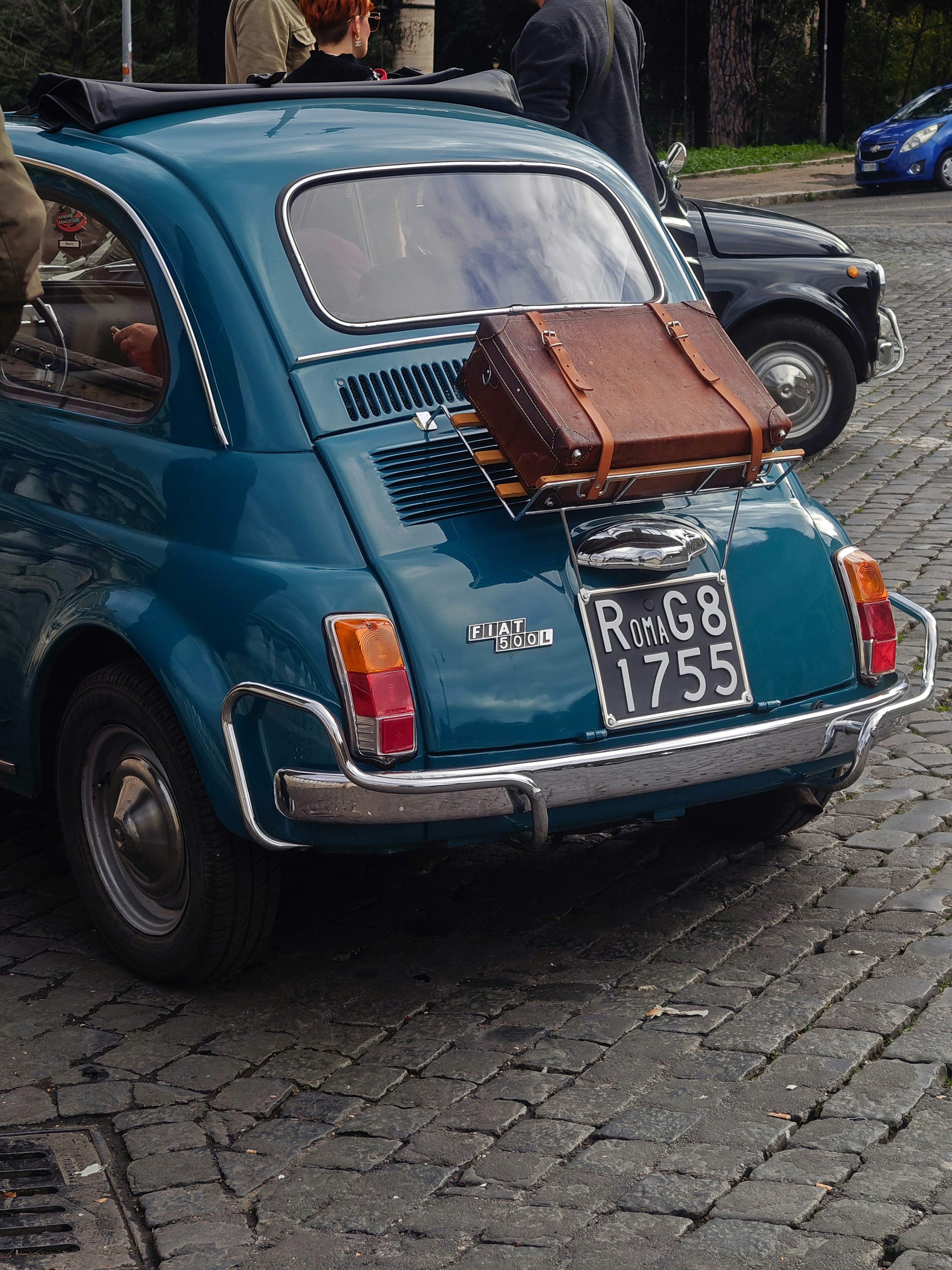 Vintage turquoise fiat 500 with luggage rack