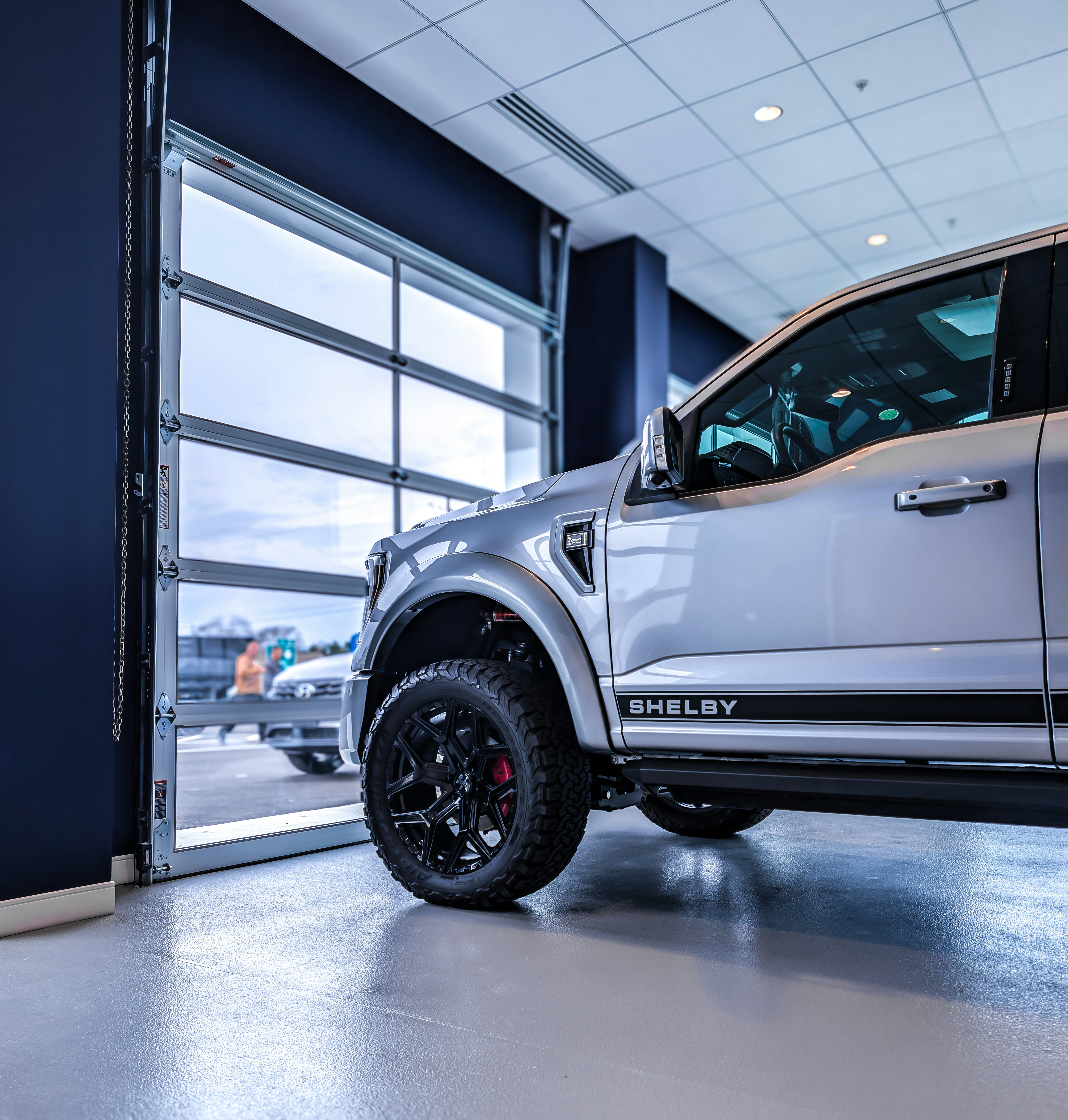 Behold the magnificent Shelby F-150, a silver masterpiece radiating raw power and sophistication. Its aggressive lifted stance and pristine finish command the showroom, promising unbridled adventure and high-octane performance. Boulevard Ford in Millsboro.
