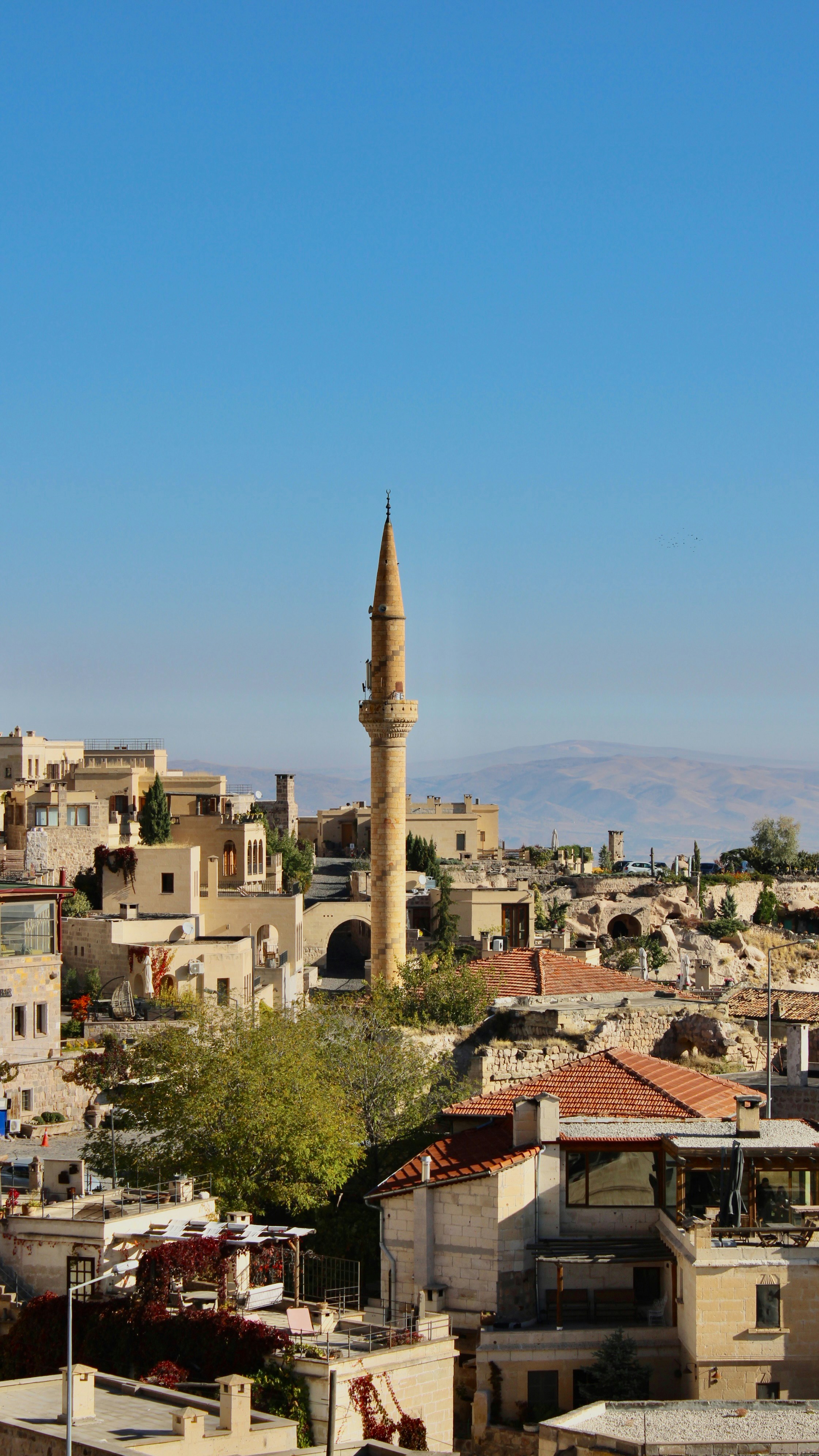 Minaret Amid Stone: A Quiet City Under a Clear Sky