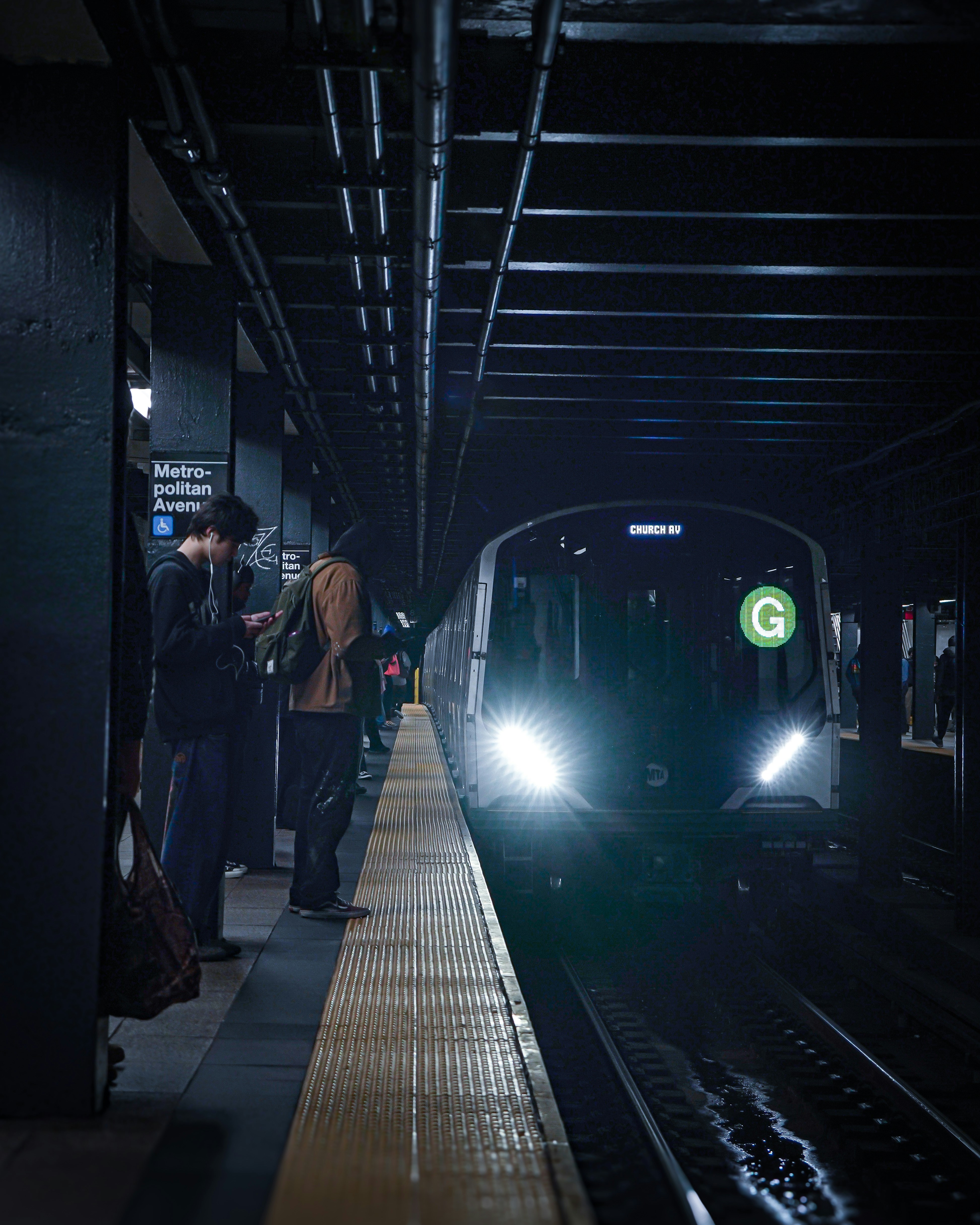 Underground G-Station: A Train Halts as Commuters Await