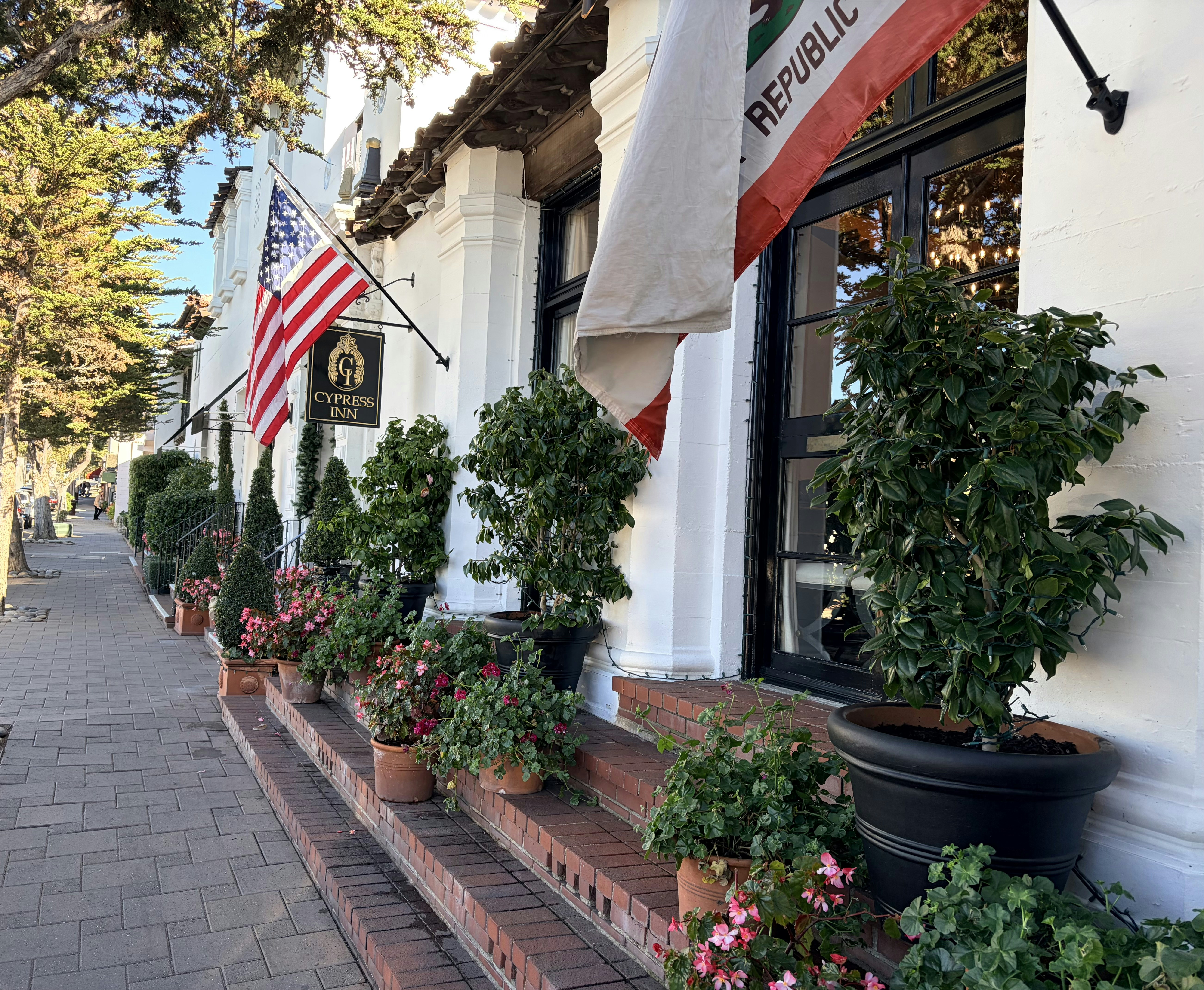 Building entrance with american and california flags.