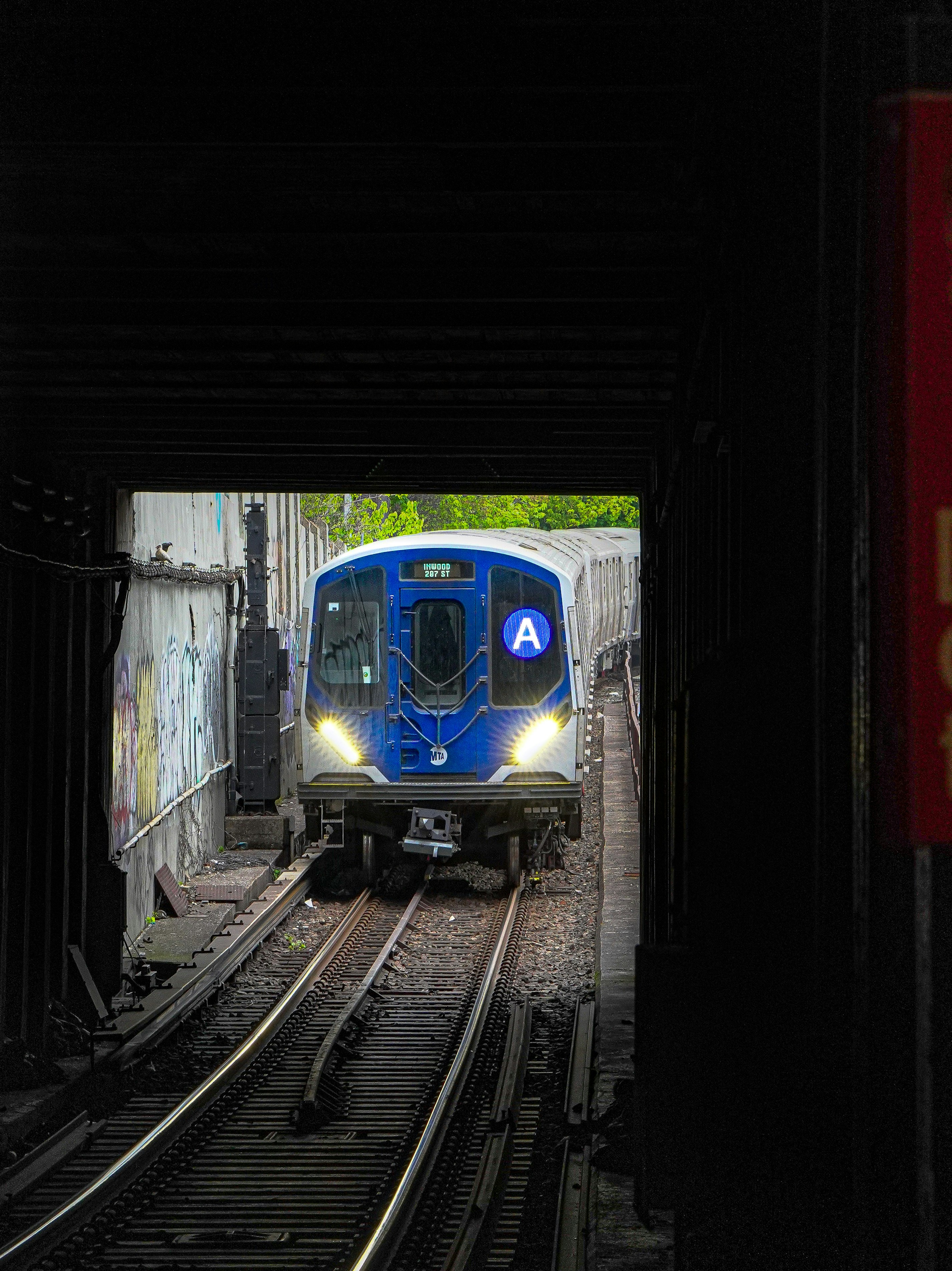 A blue subway train approaches on tracks photo – Free Travel Image on ...