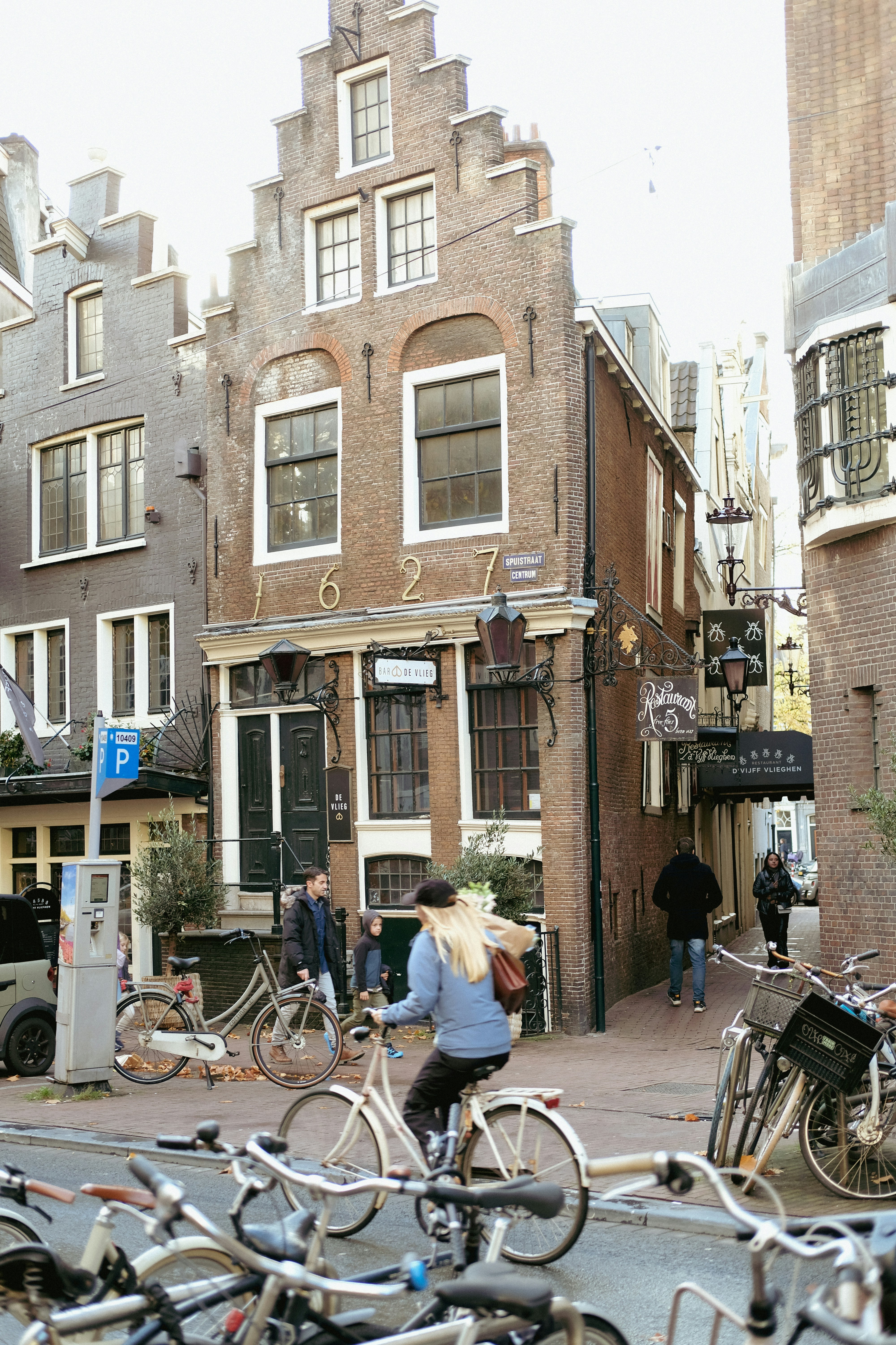 Bicycle Parade by a Historic Dutch-Style Brick Facade
