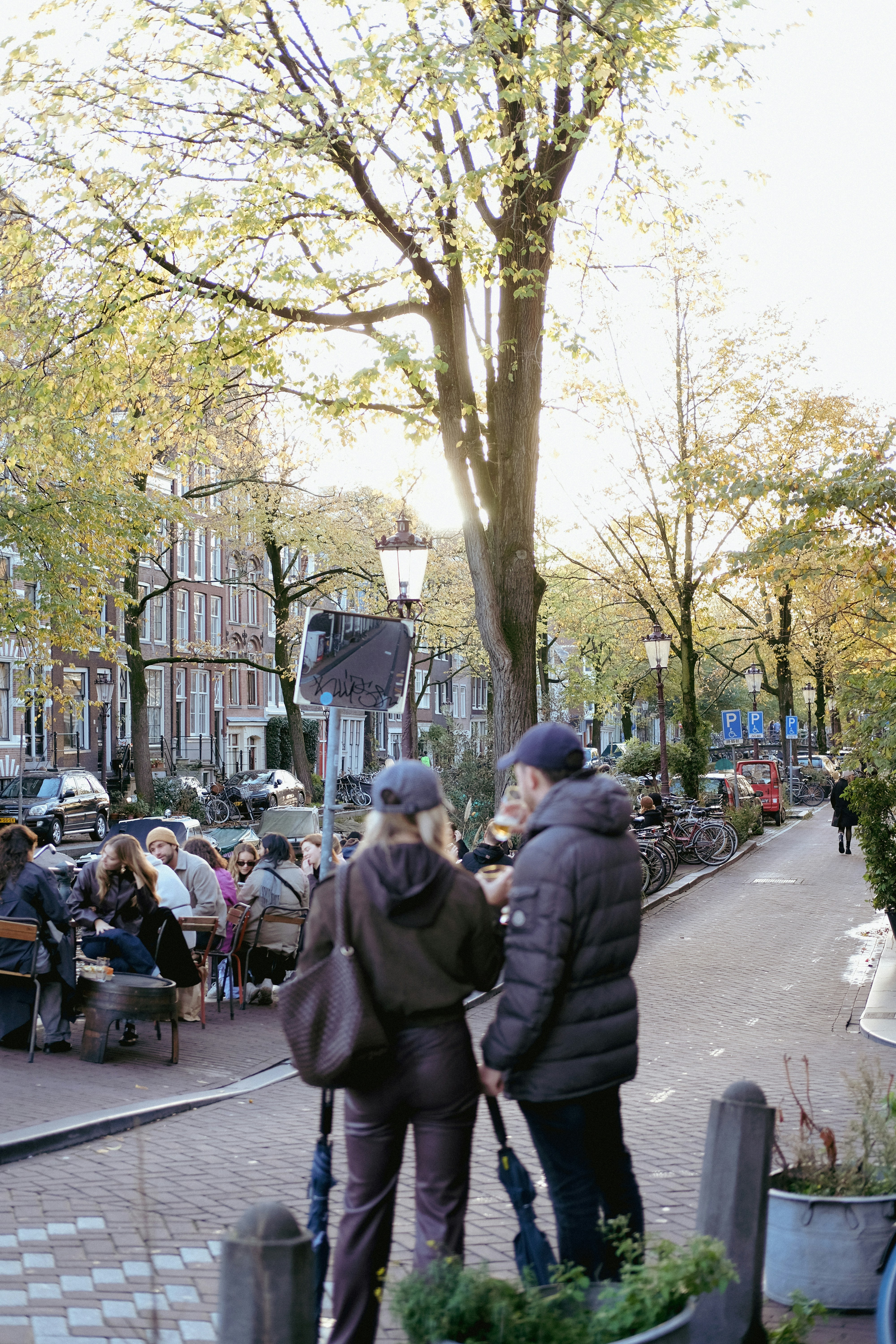 Sunlit Café Conversations on a Lively European Street
