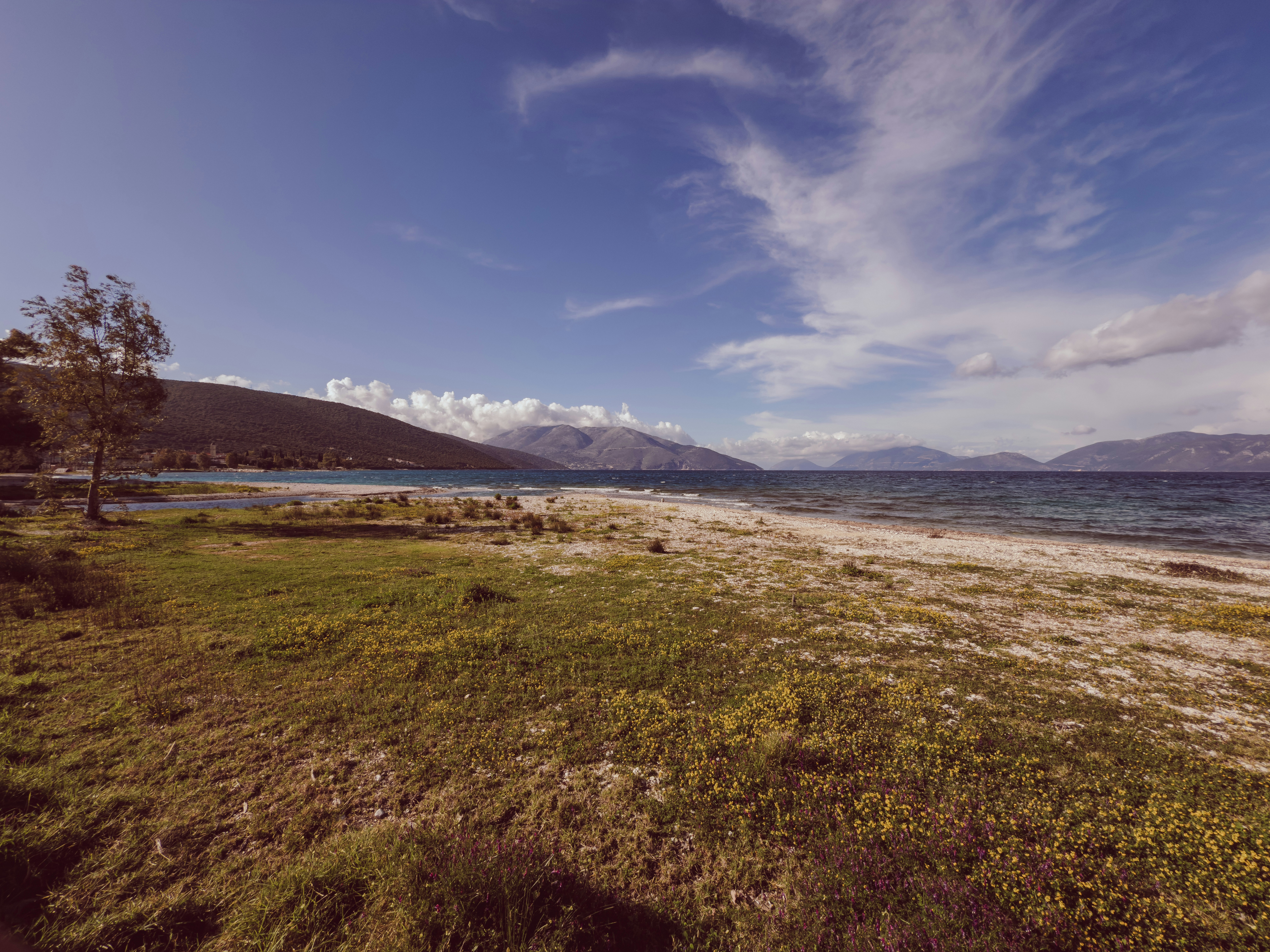 Lakeside Vistas: Evening Light on the Pebble Shore