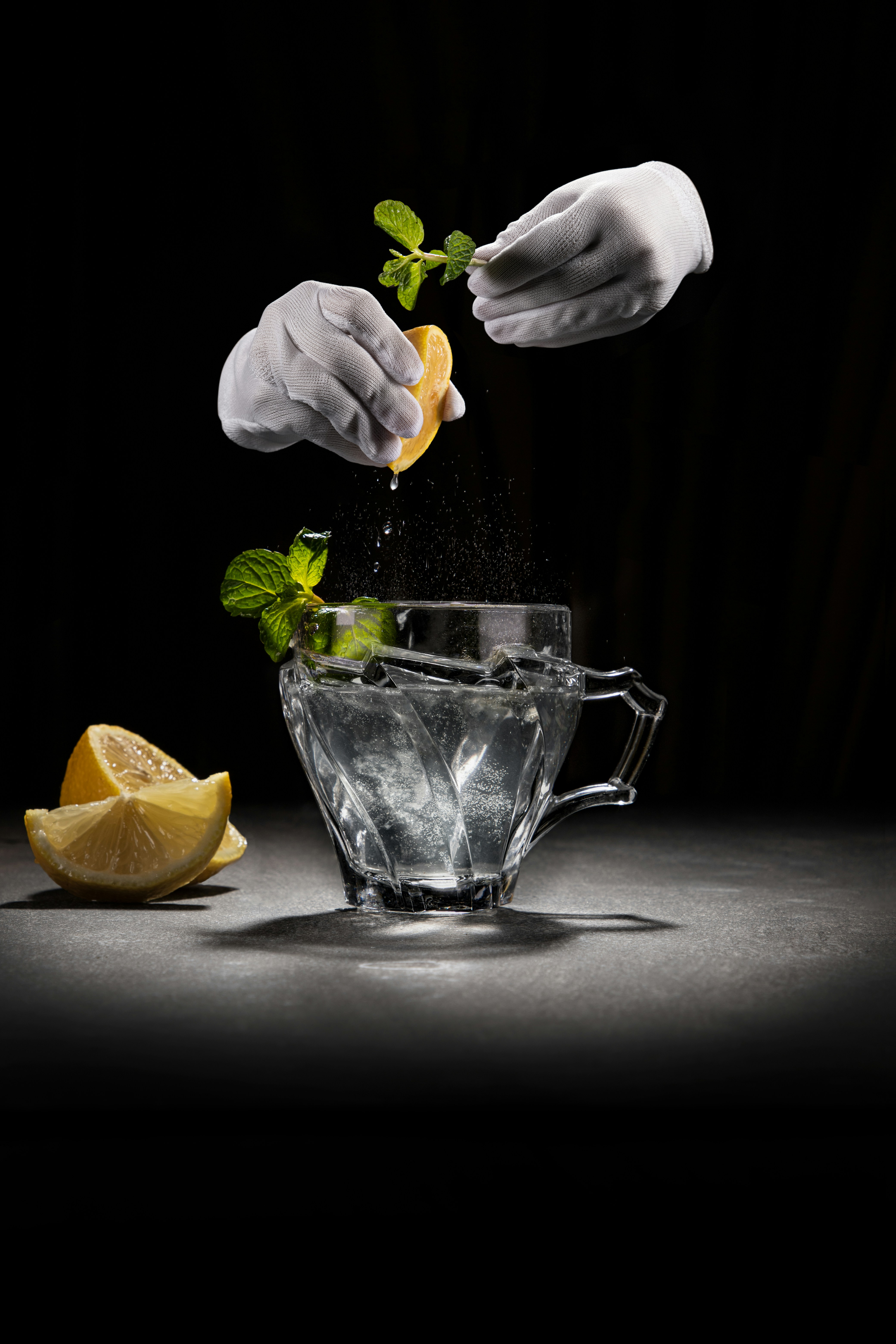 Citrus Burst: Lemon Squeeze Over a Glass of Sparkling Water