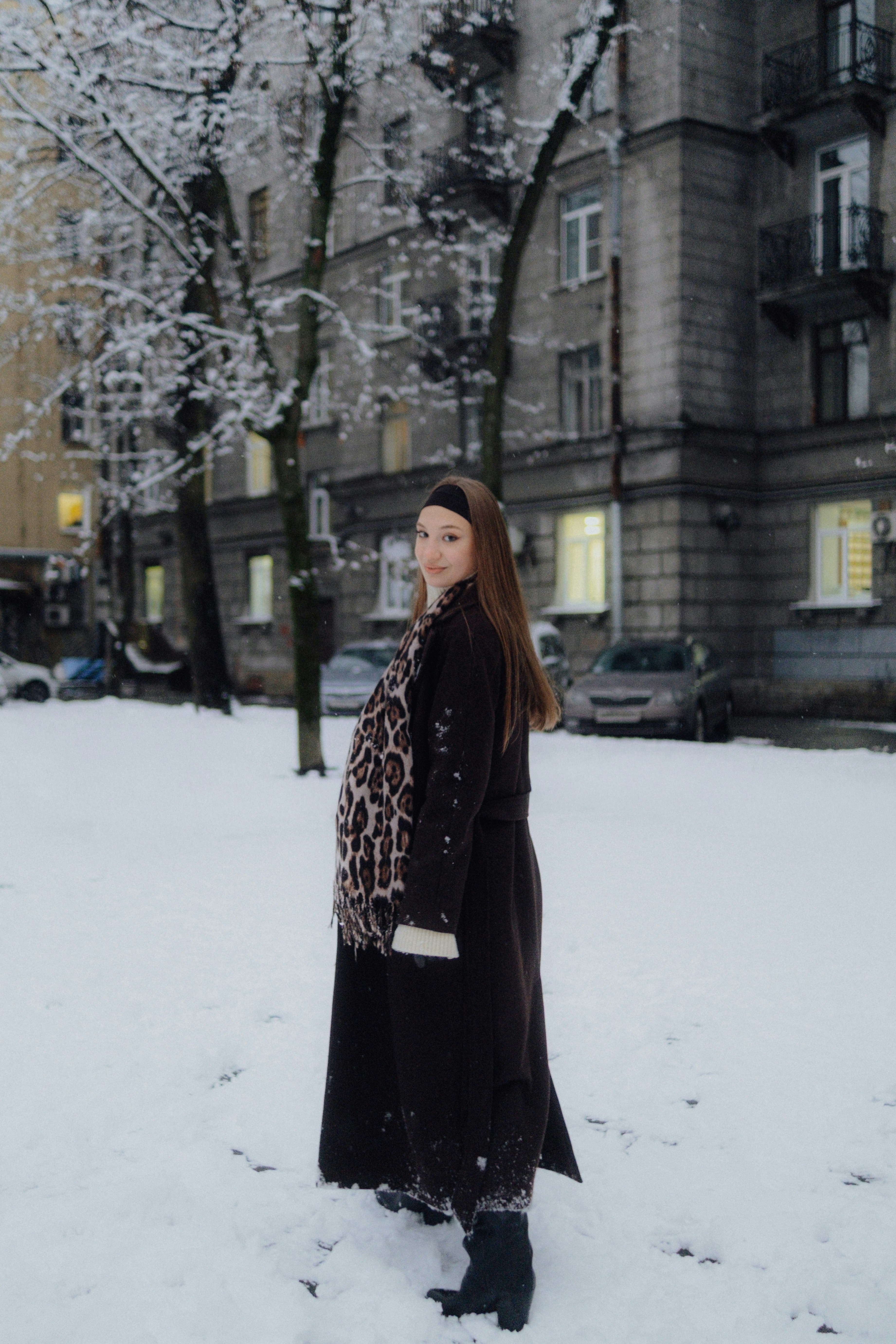 Winter Portrait in a Snowy Urban Courtyard