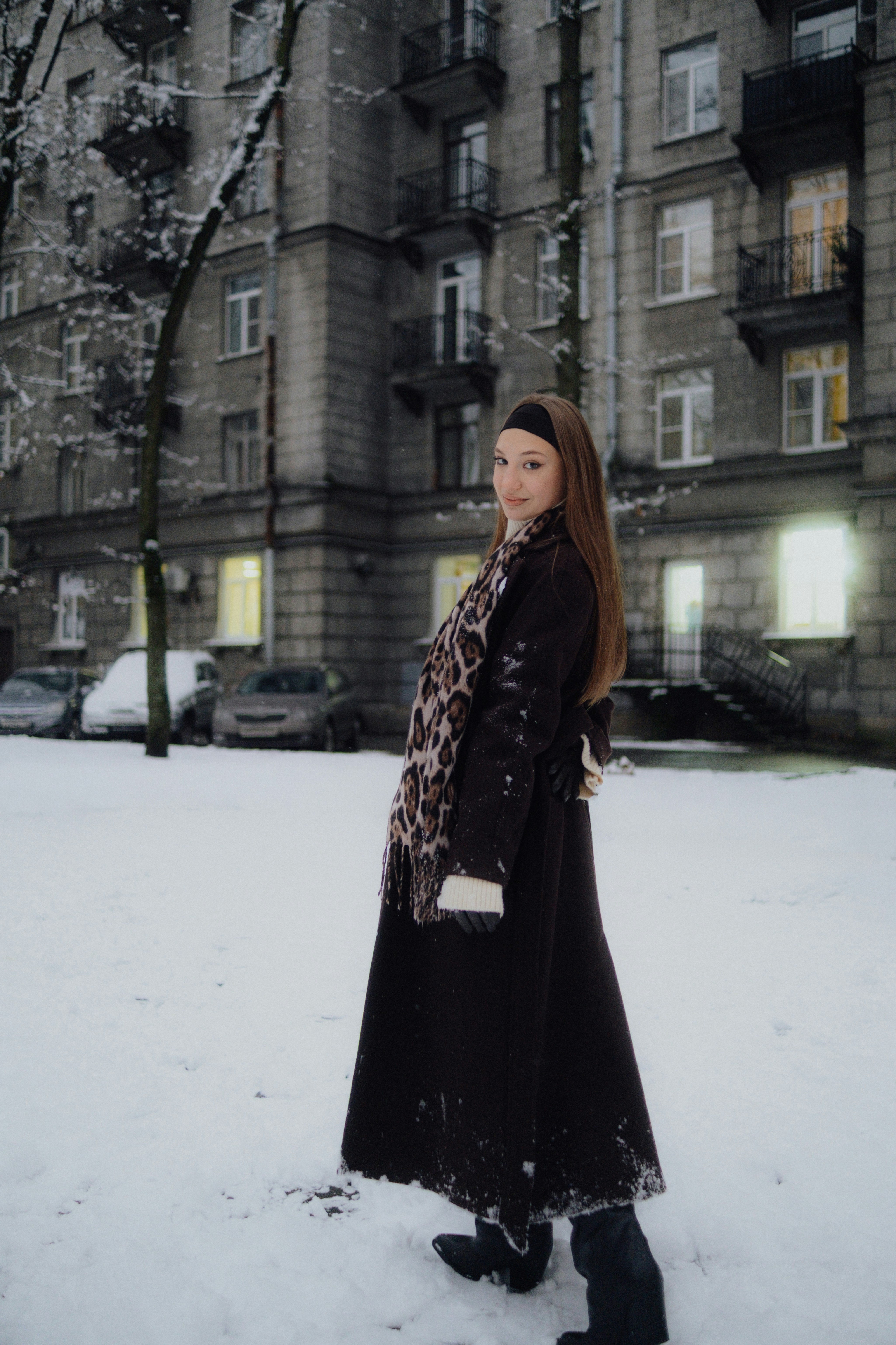 Winter Portrait in a Snowy City Courtyard