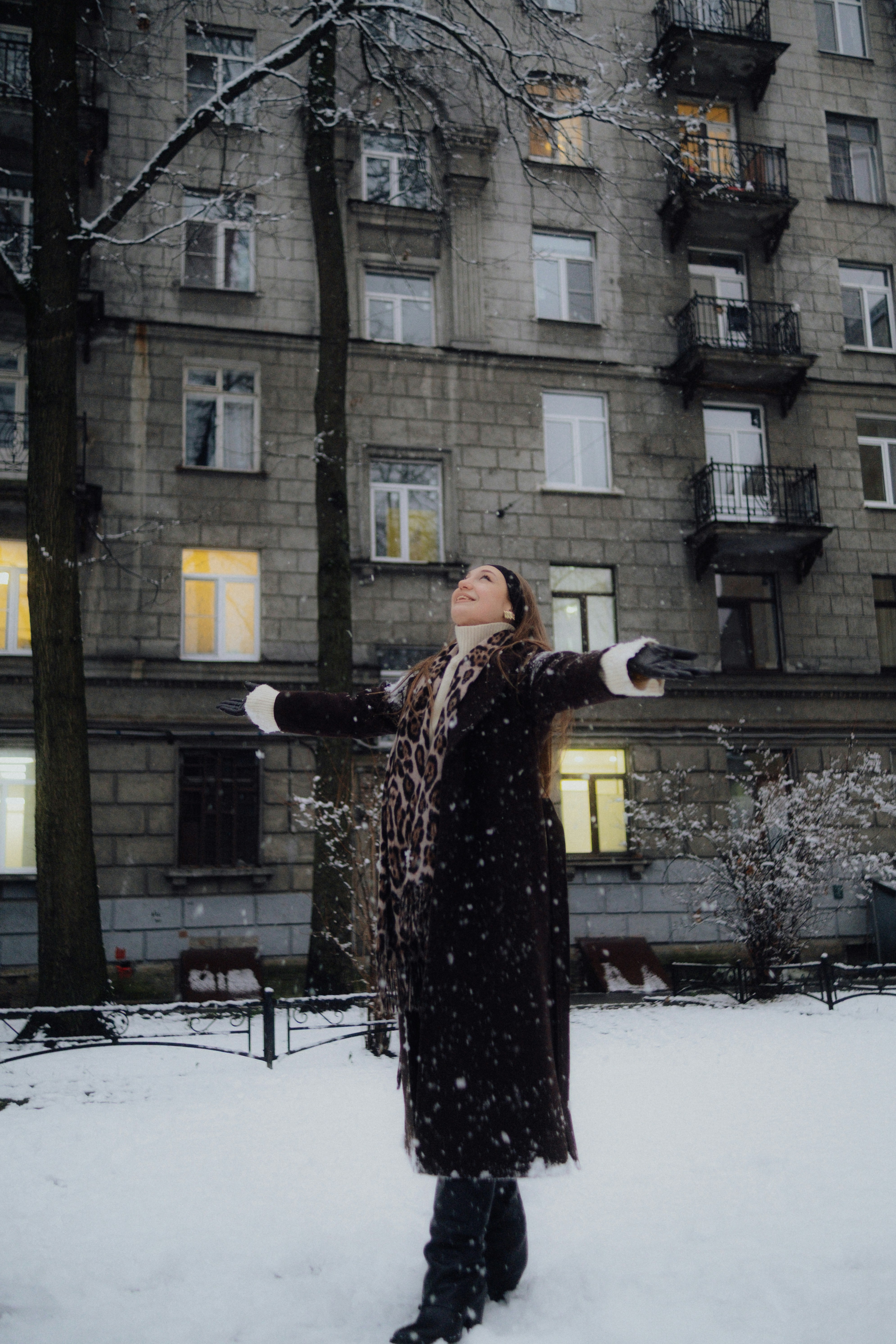 Winter Ascension: A Woman Spreads Her Arms Beneath Snowfall