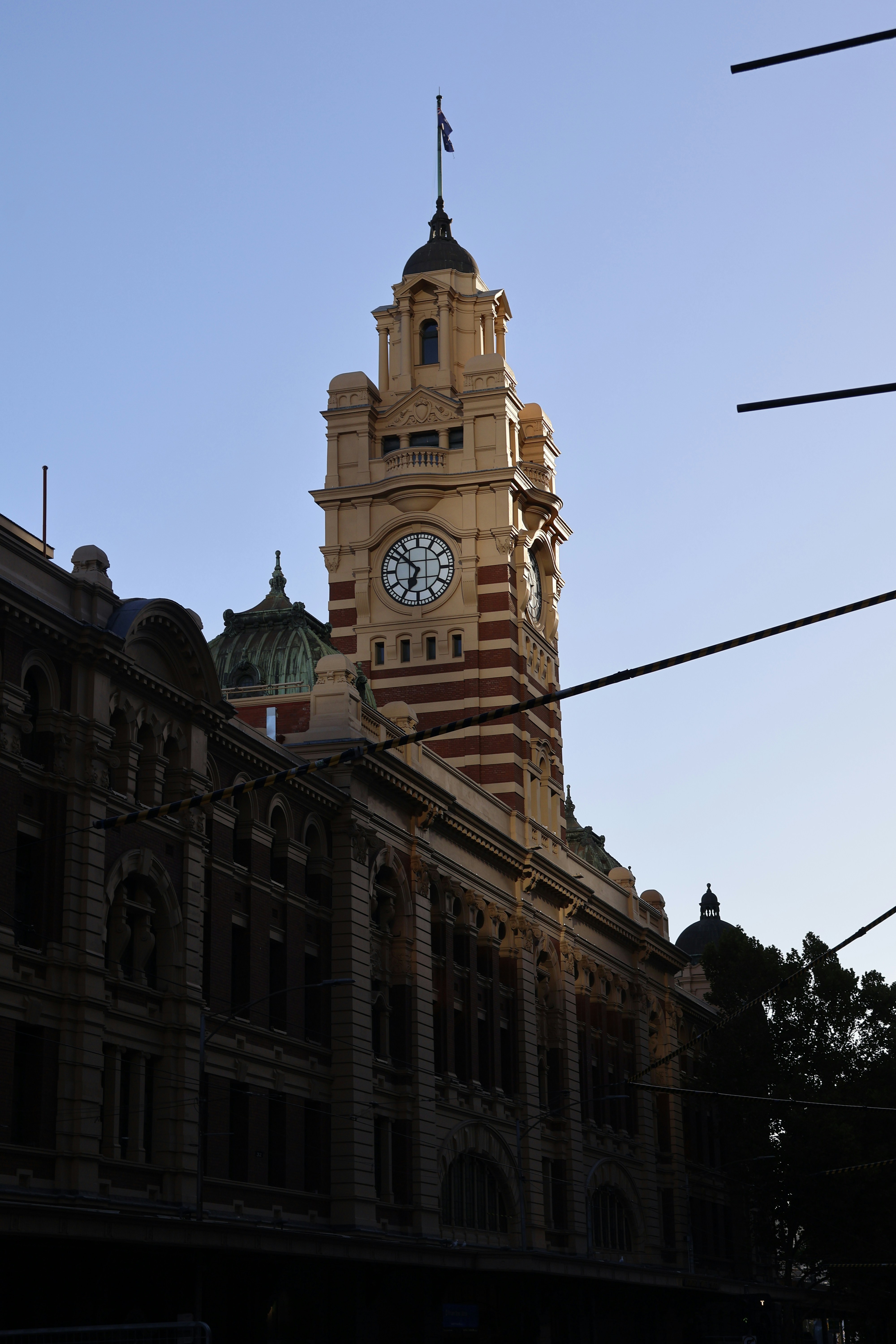 Clocktower Echoes: A Victorian Facade Reaching Toward a Clear Sky