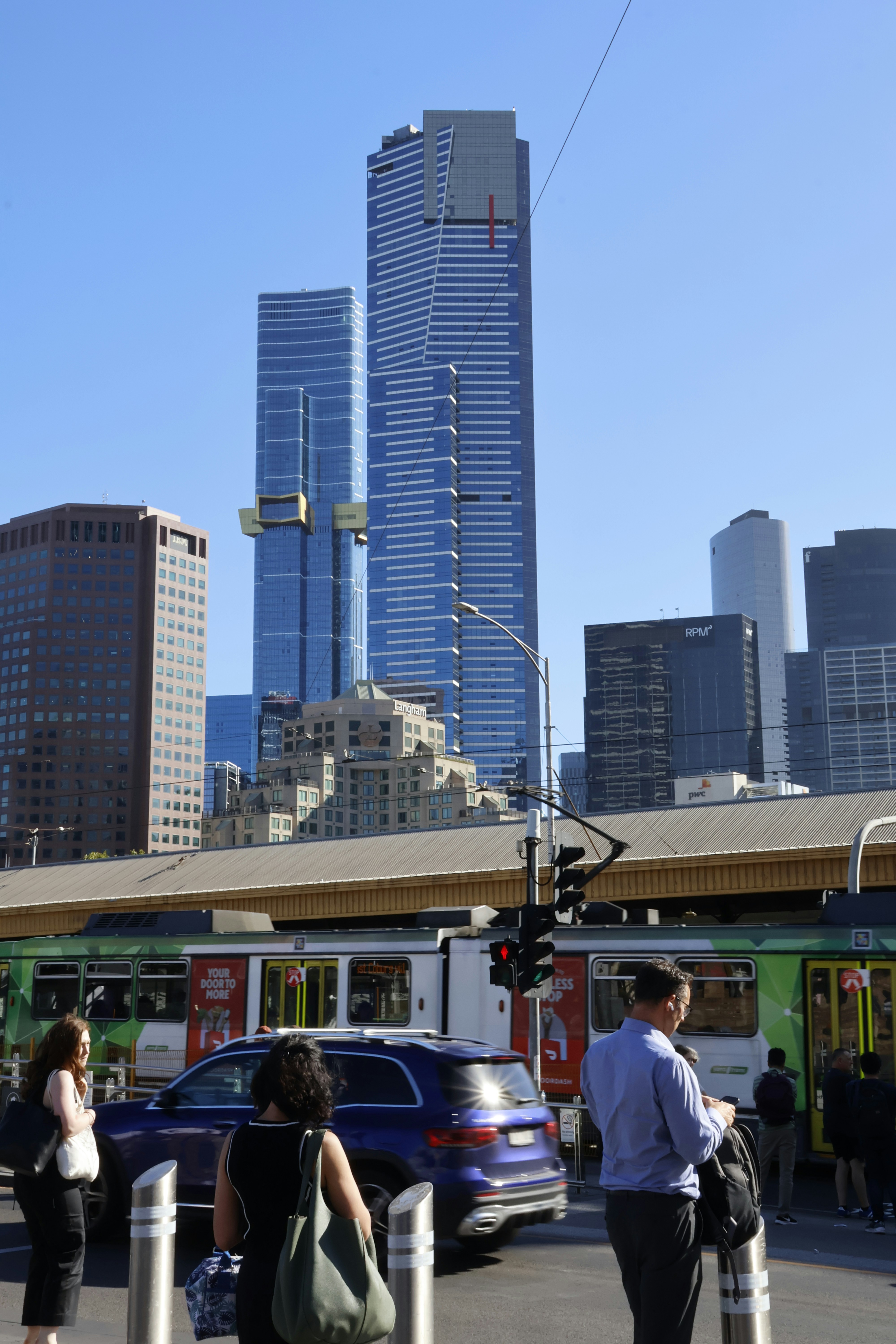 Urban Cascade: Glass Towers over a Bustling Transit Core