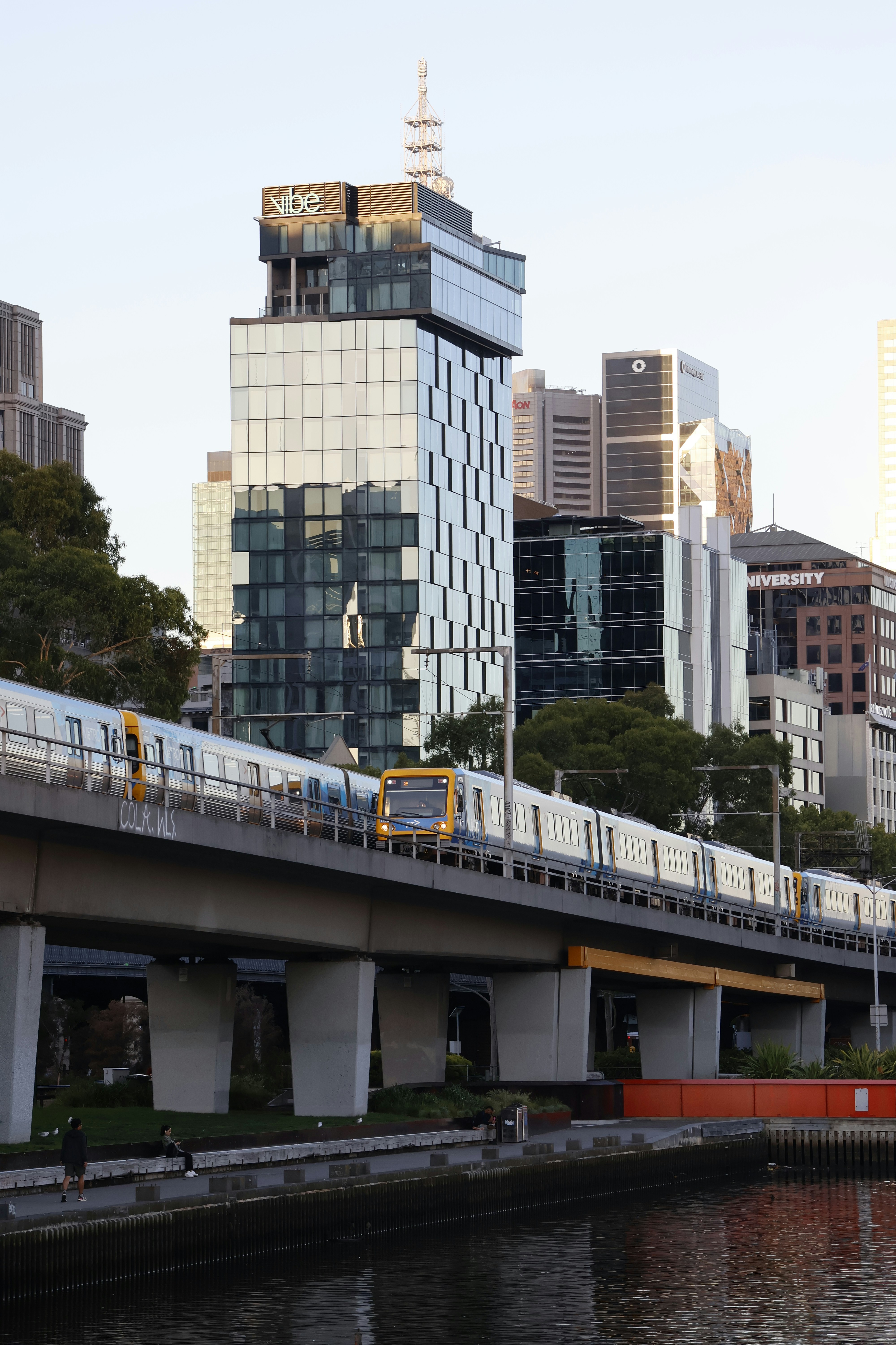 City Elevation: A commuter train glides over a civic skyline