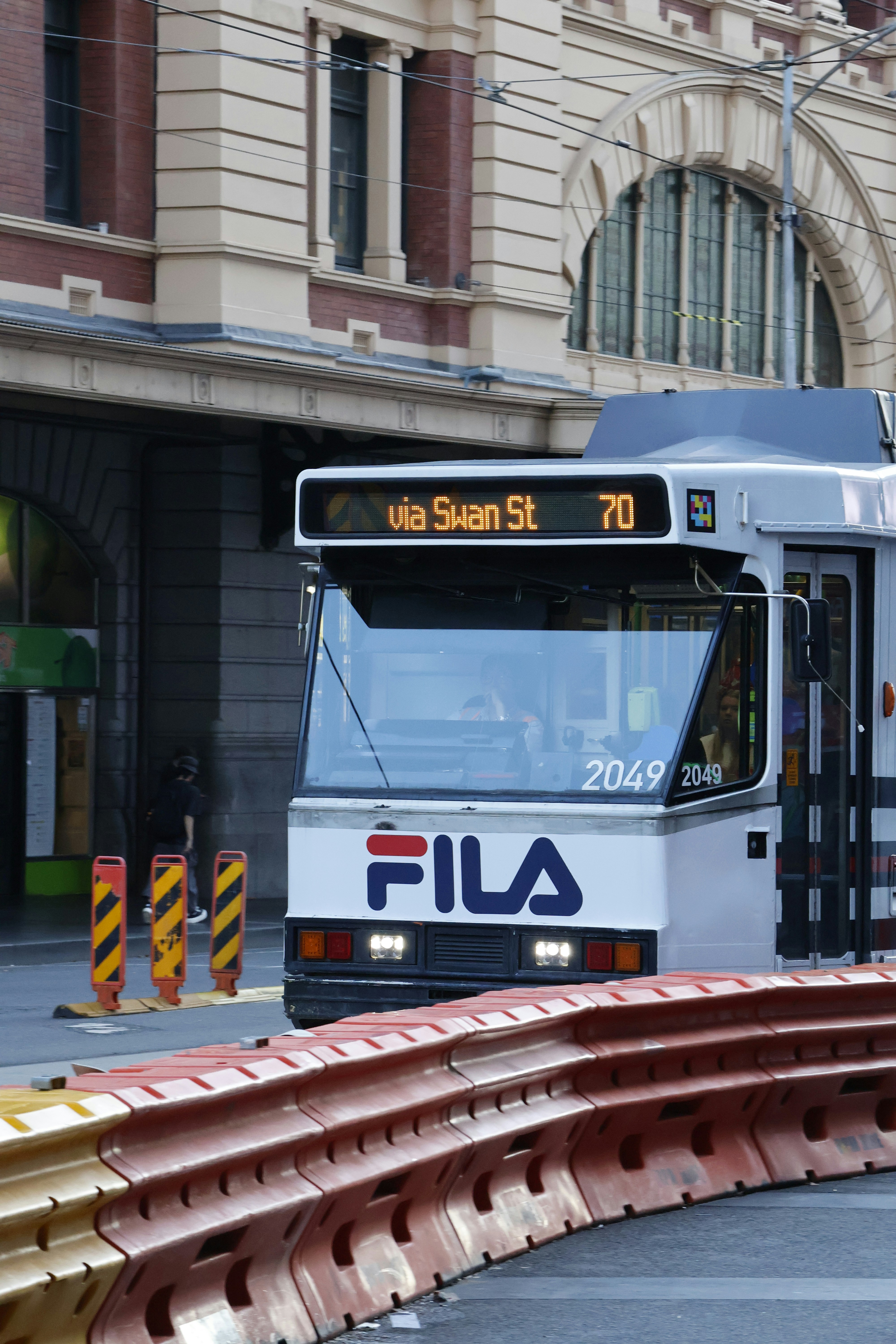 Blue-and-White FILA Bus at a City Edge