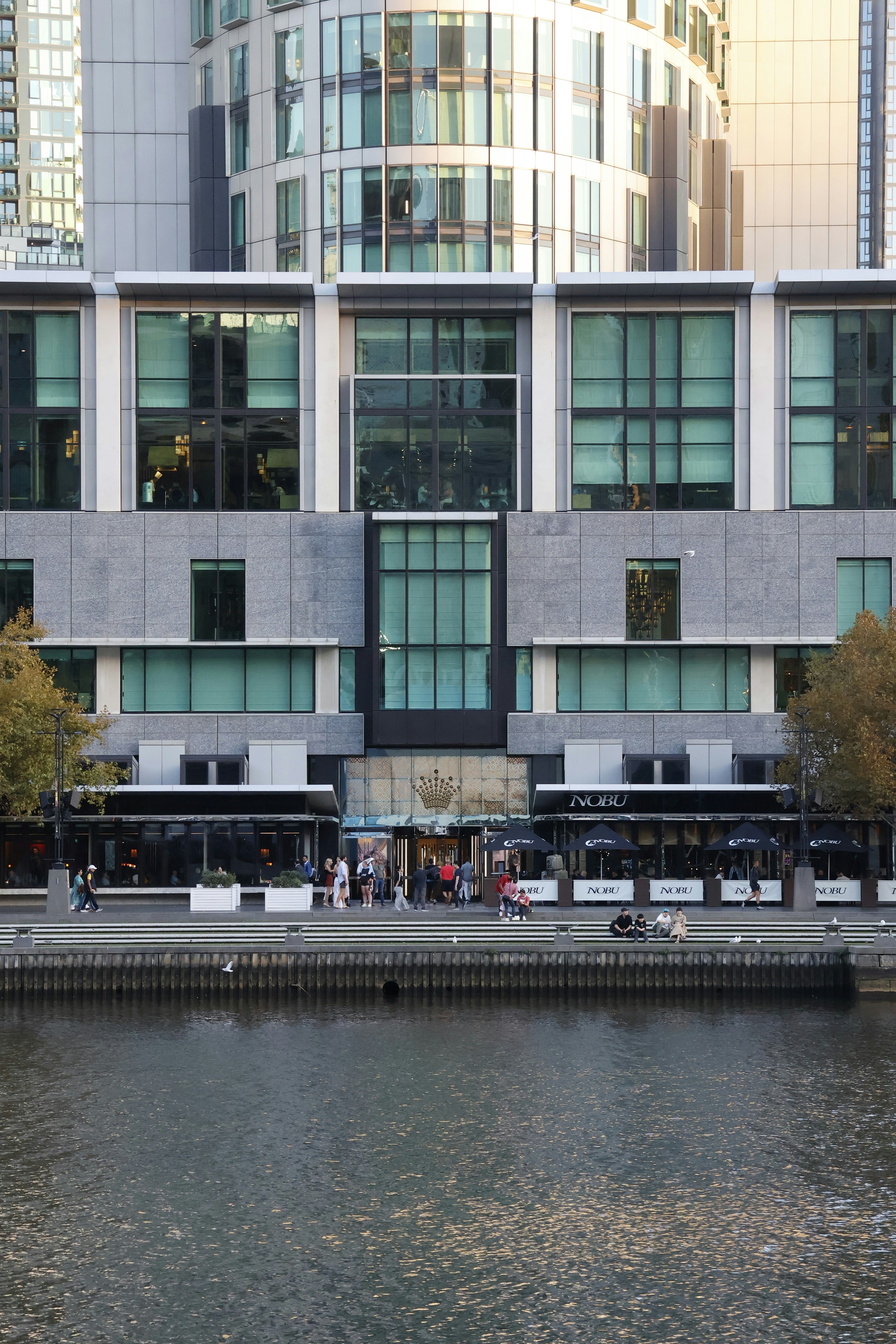 Waterfront Facade: Glassy Towers Framing a Riverside Scene
