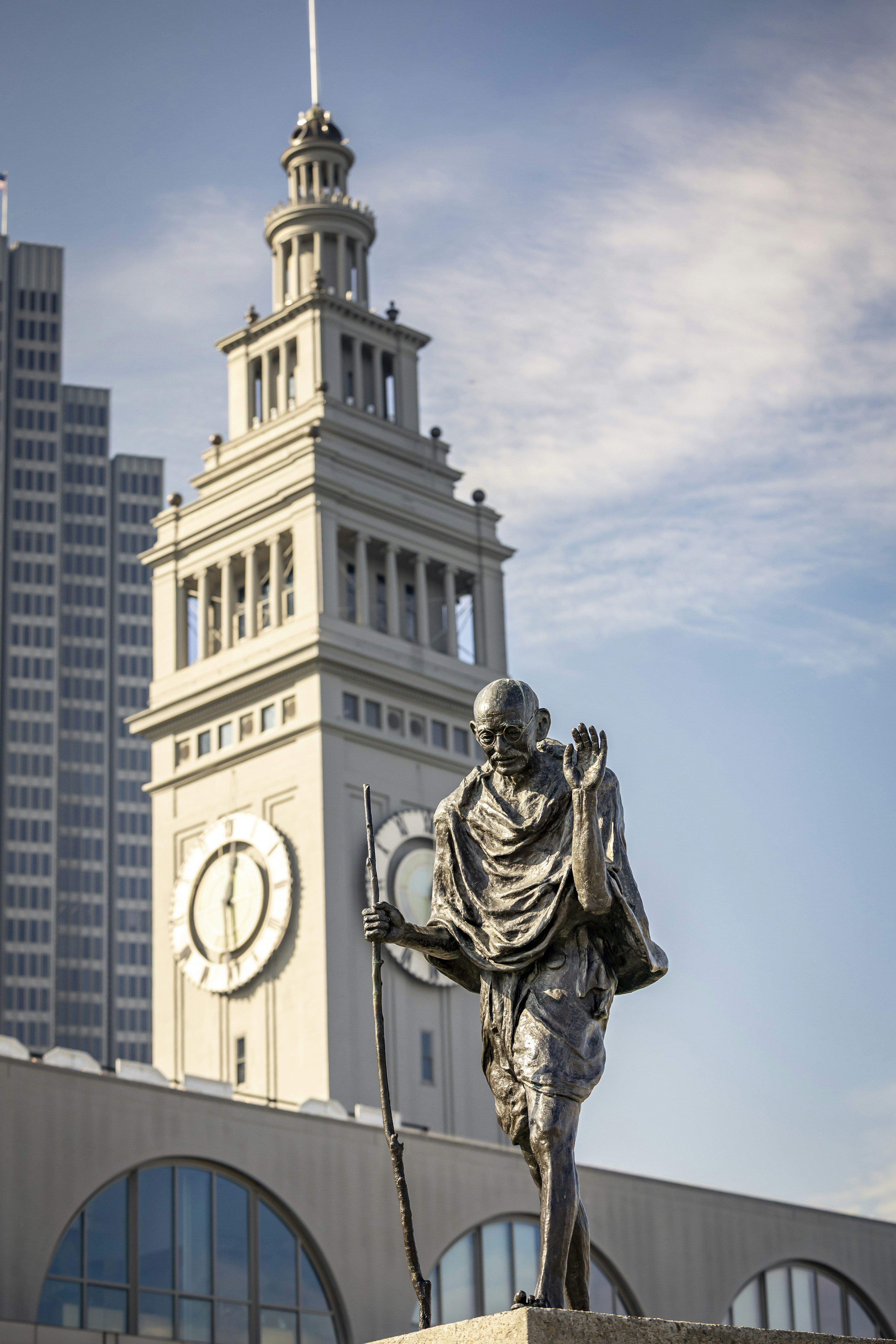 Statue Gesture Against a Clocktower Sky