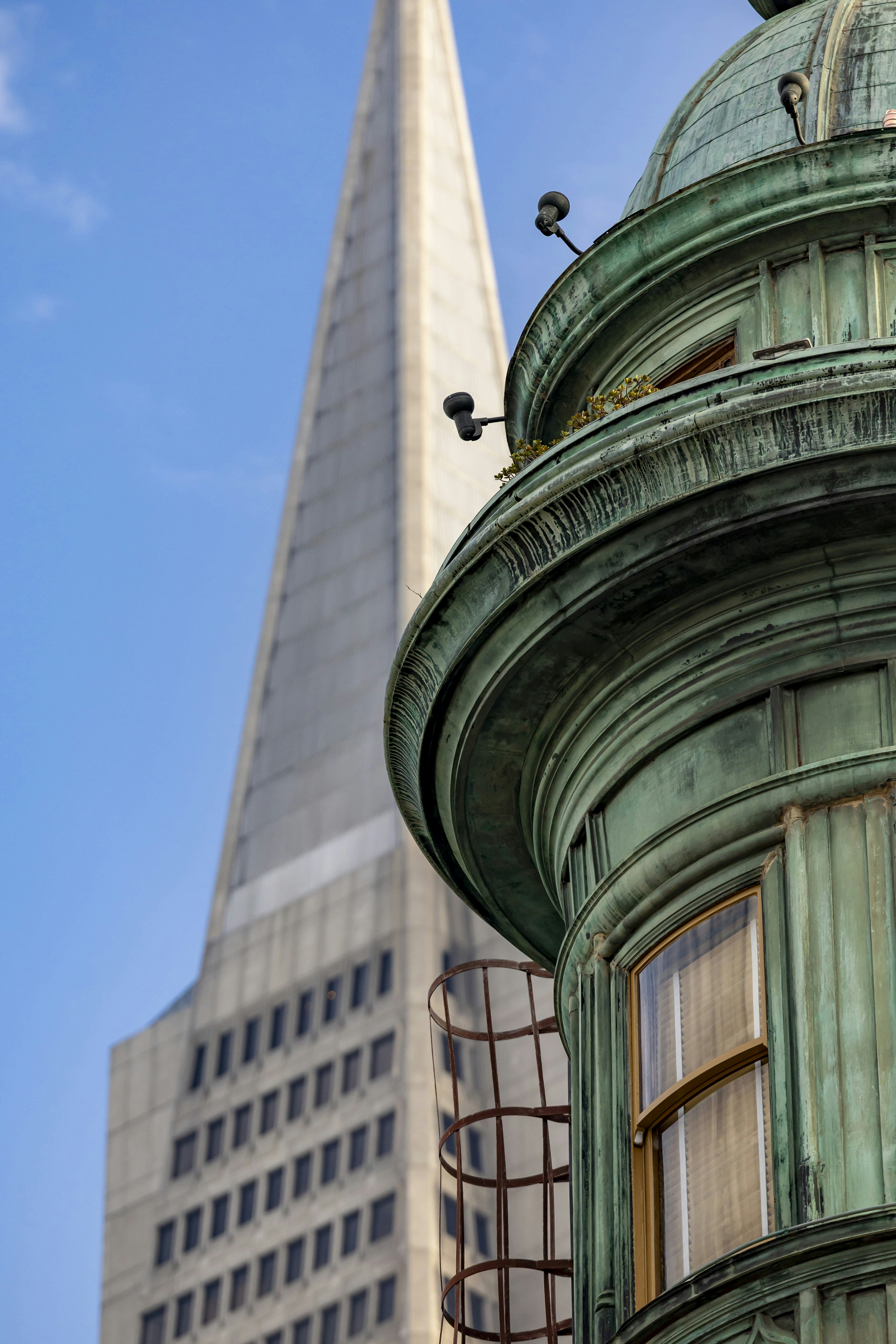 Coppery turret meets glass spire: a city architectural duet