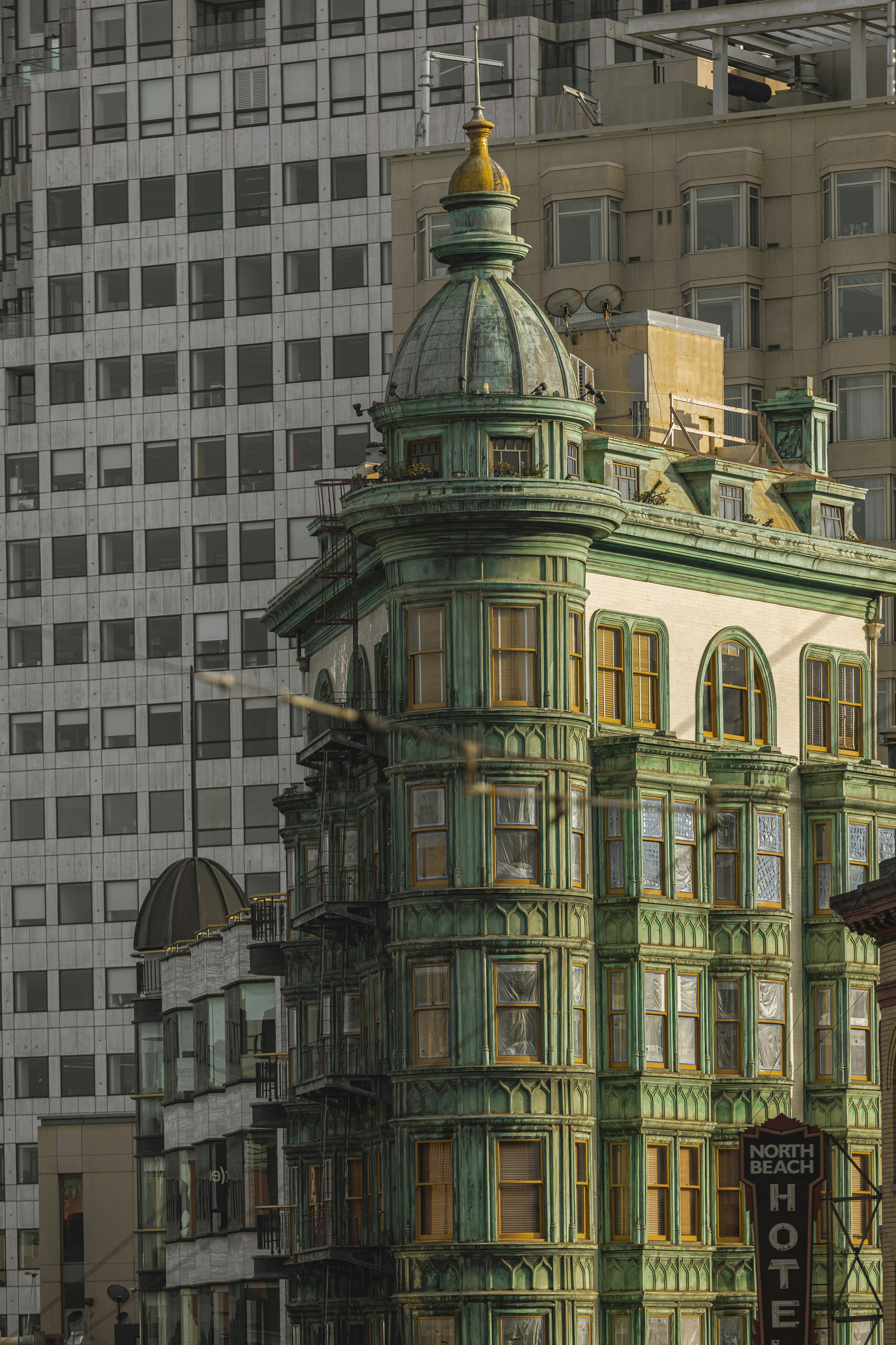 Green Dome, Golden Accents: A Historic Facade Amid Skyscrapers
