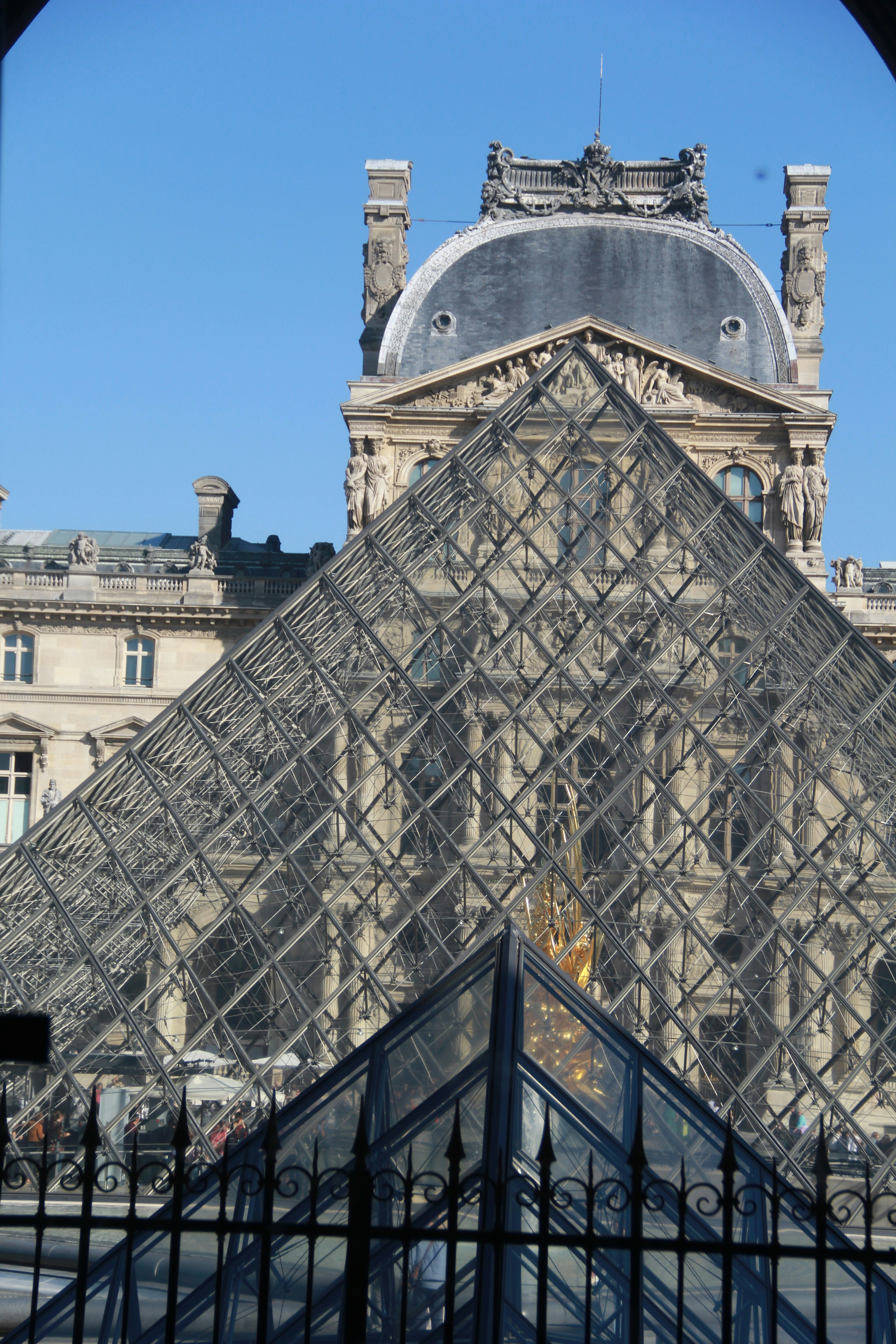 Glass Pyramid Framed by Historic Facade at Louvre