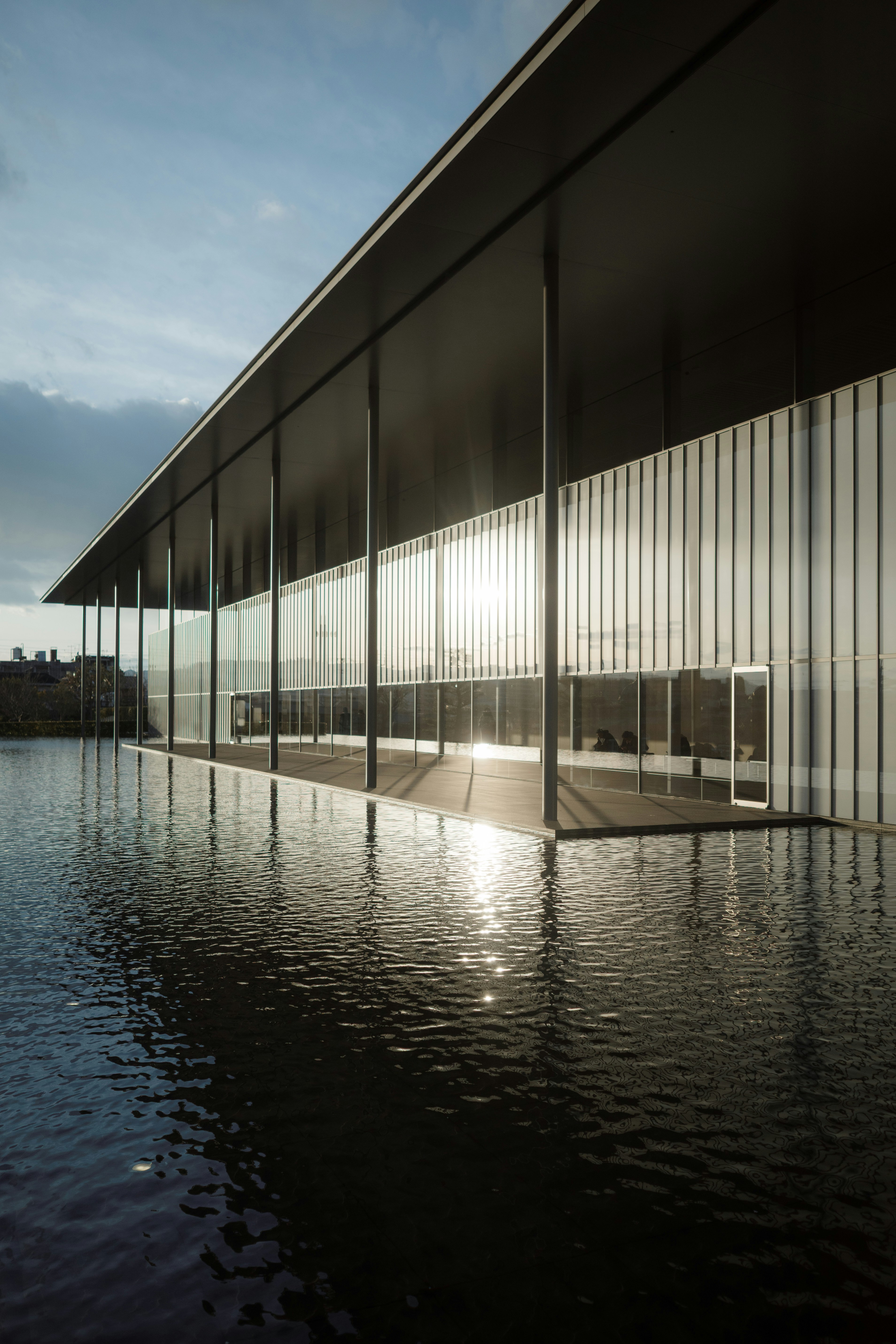 Glass and Water: Modern Pavilion Reflecting the Sky
