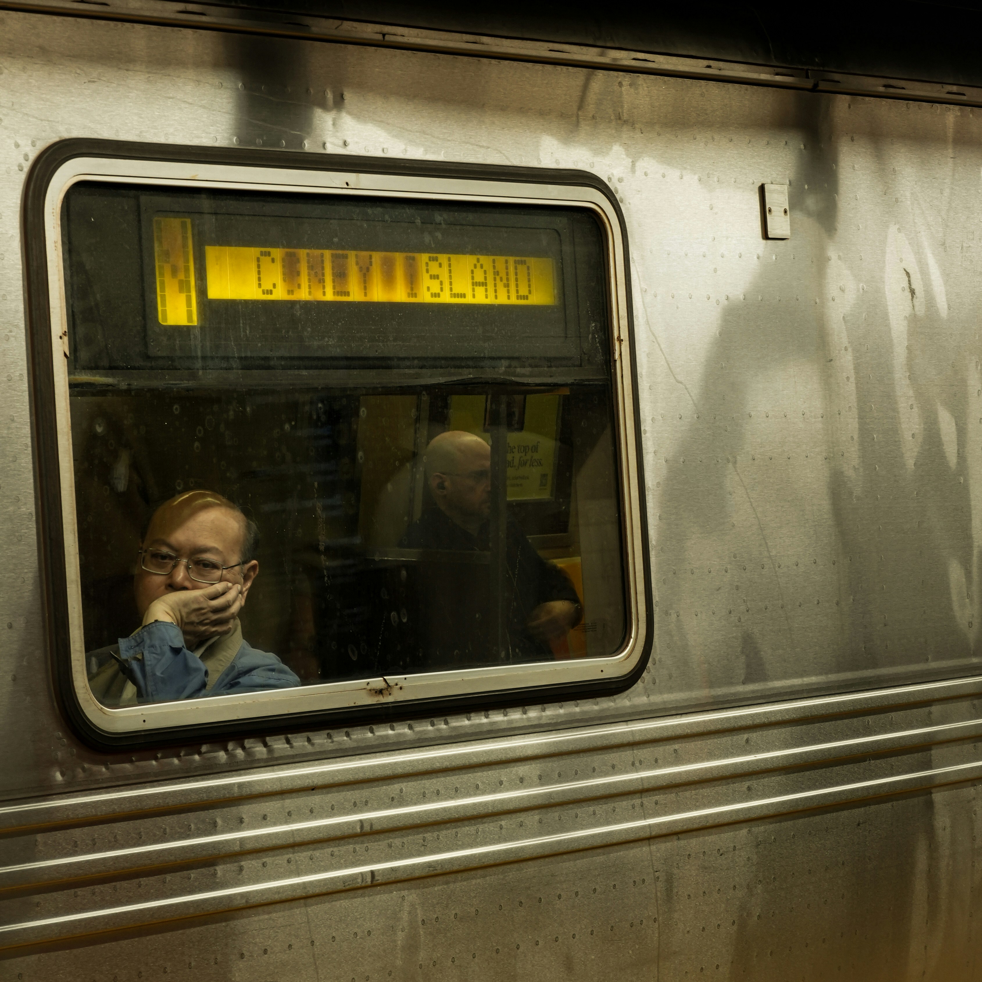Paused in the Window: A Quiet Moment on the Subway