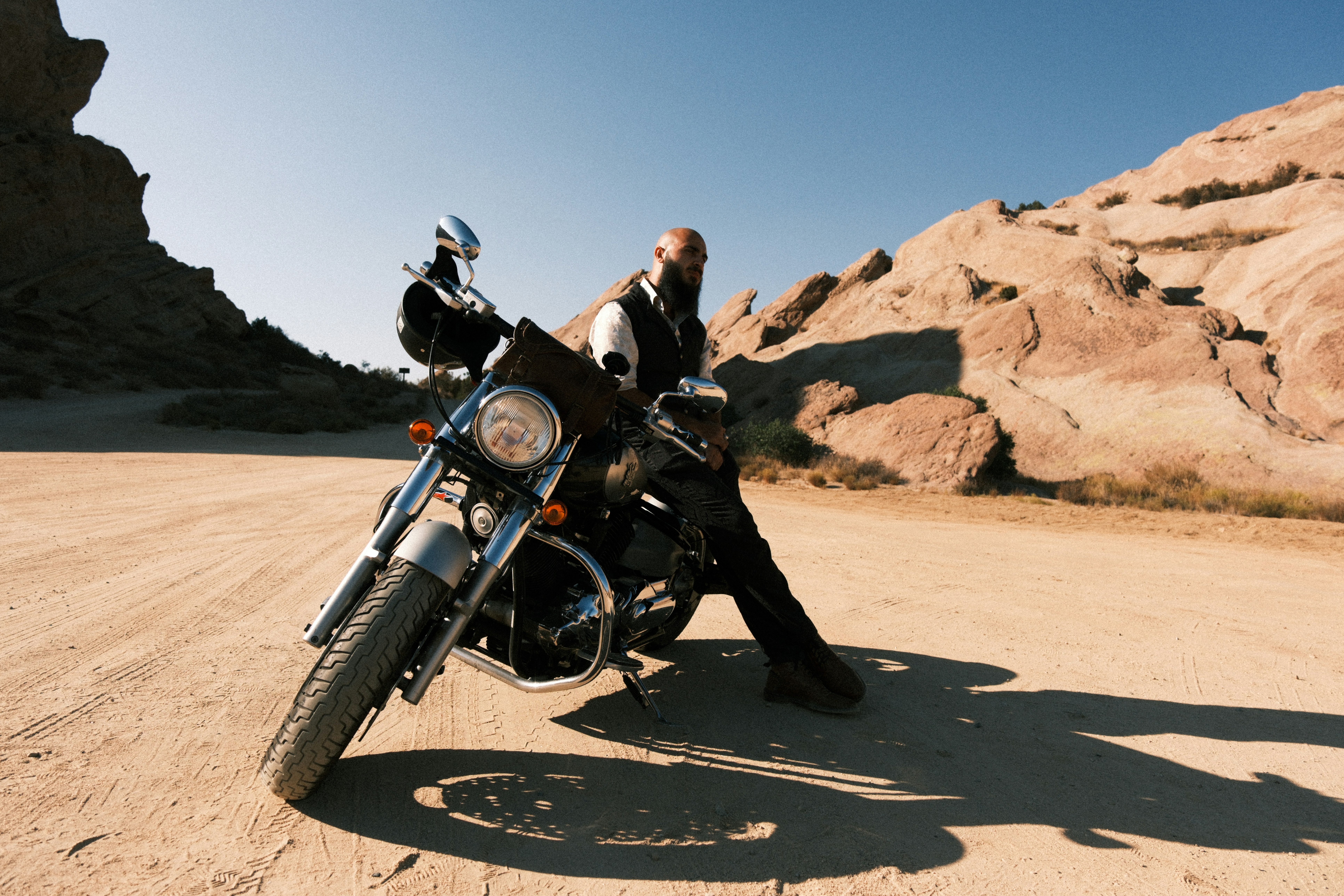Rider on the Edge: A Lone Stance Against Desert Cliffs