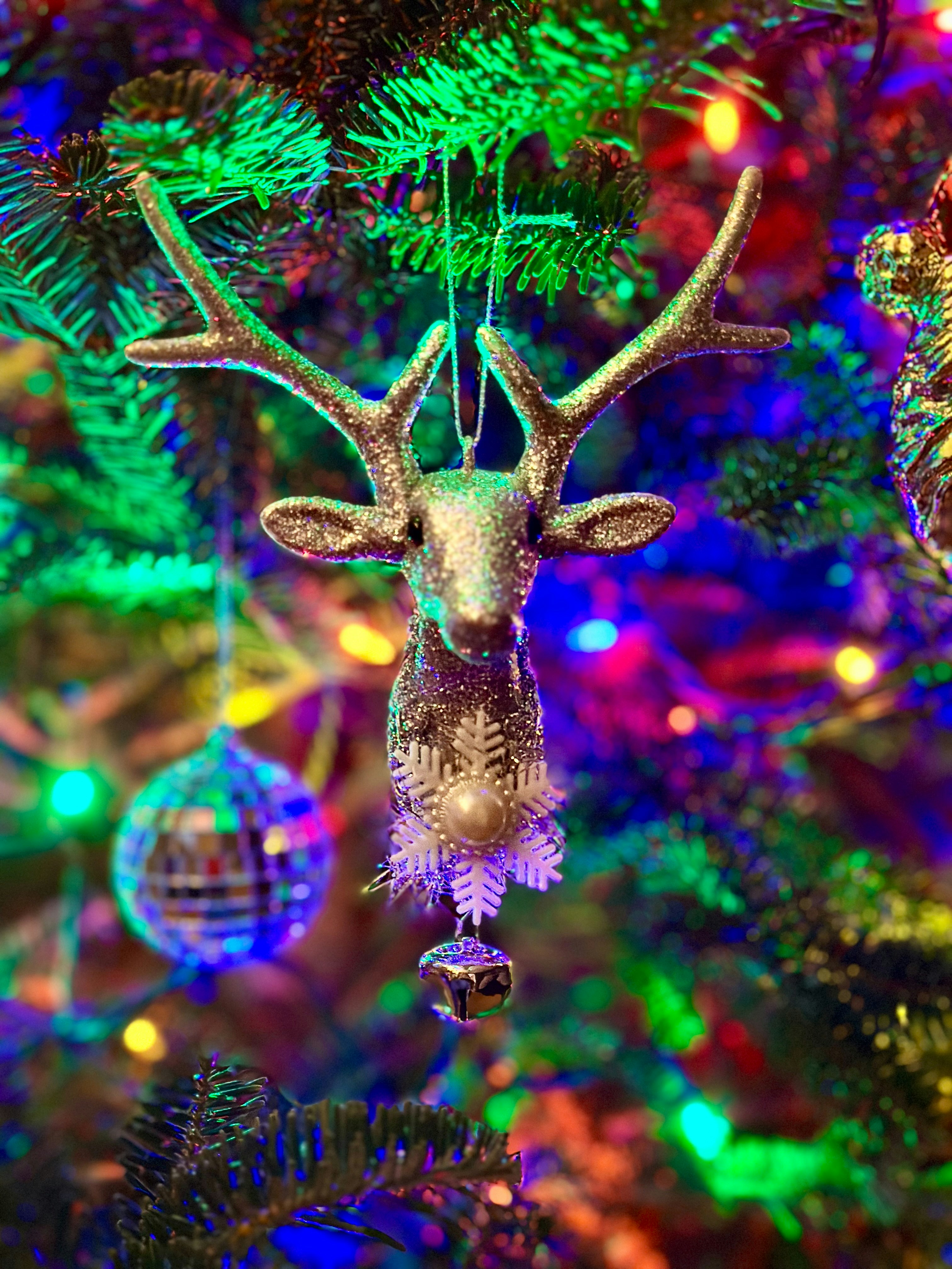 Glittering Reindeer Ornament Adorned with Snowflake Charm in Neon Holiday Glow