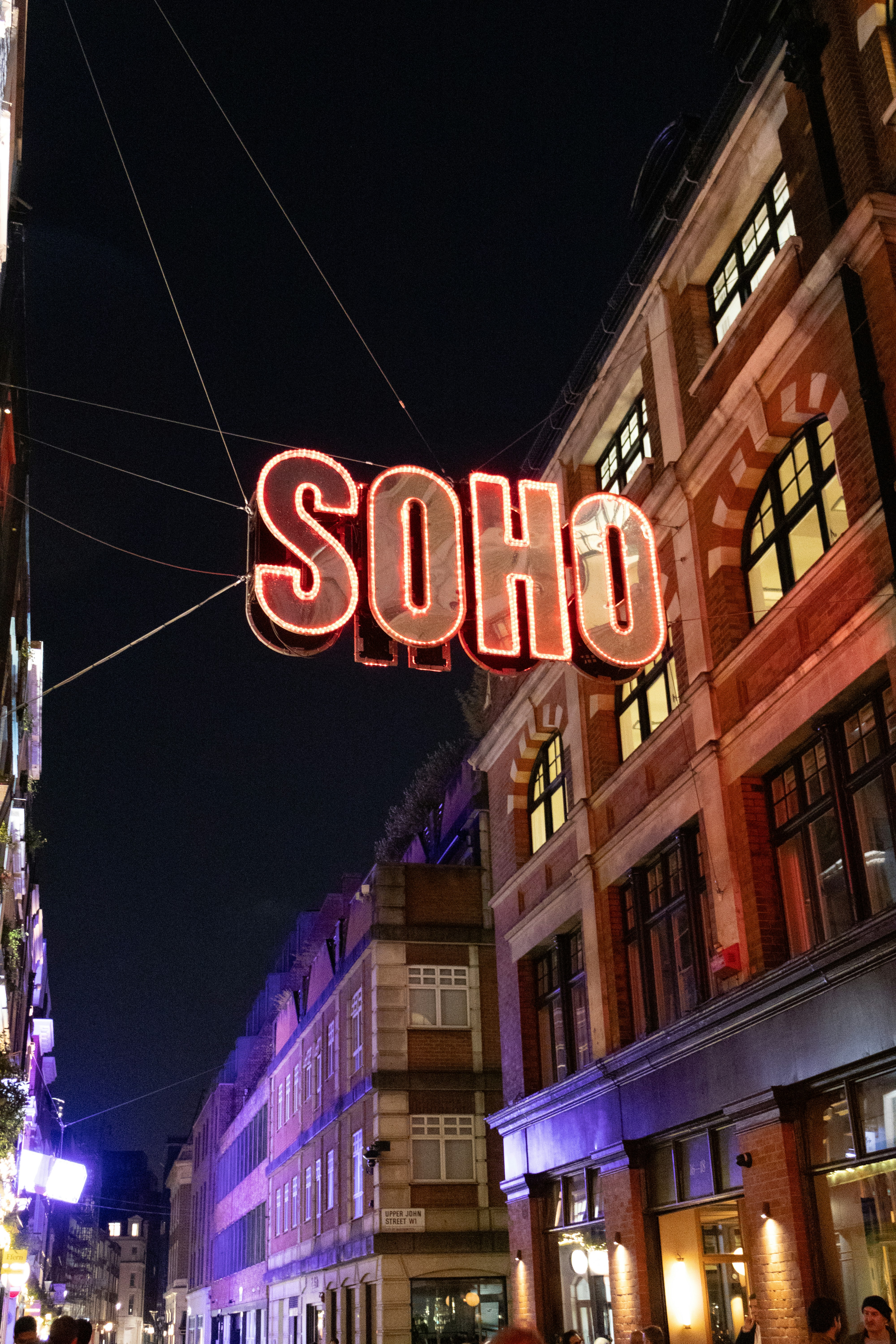 Neon SoHo Sign Across Night Facade
