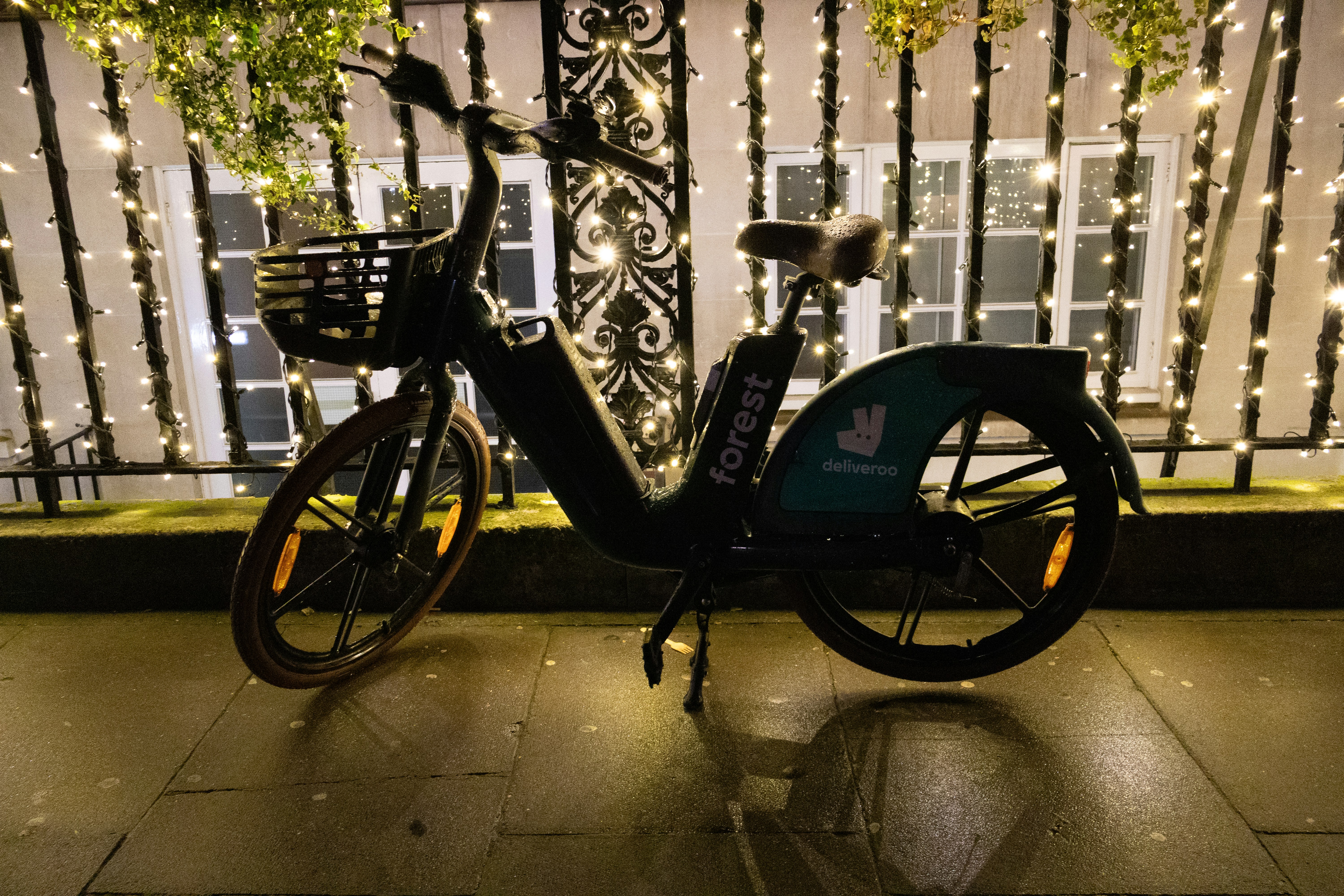 City-night E-Bike Under Festooned Lights