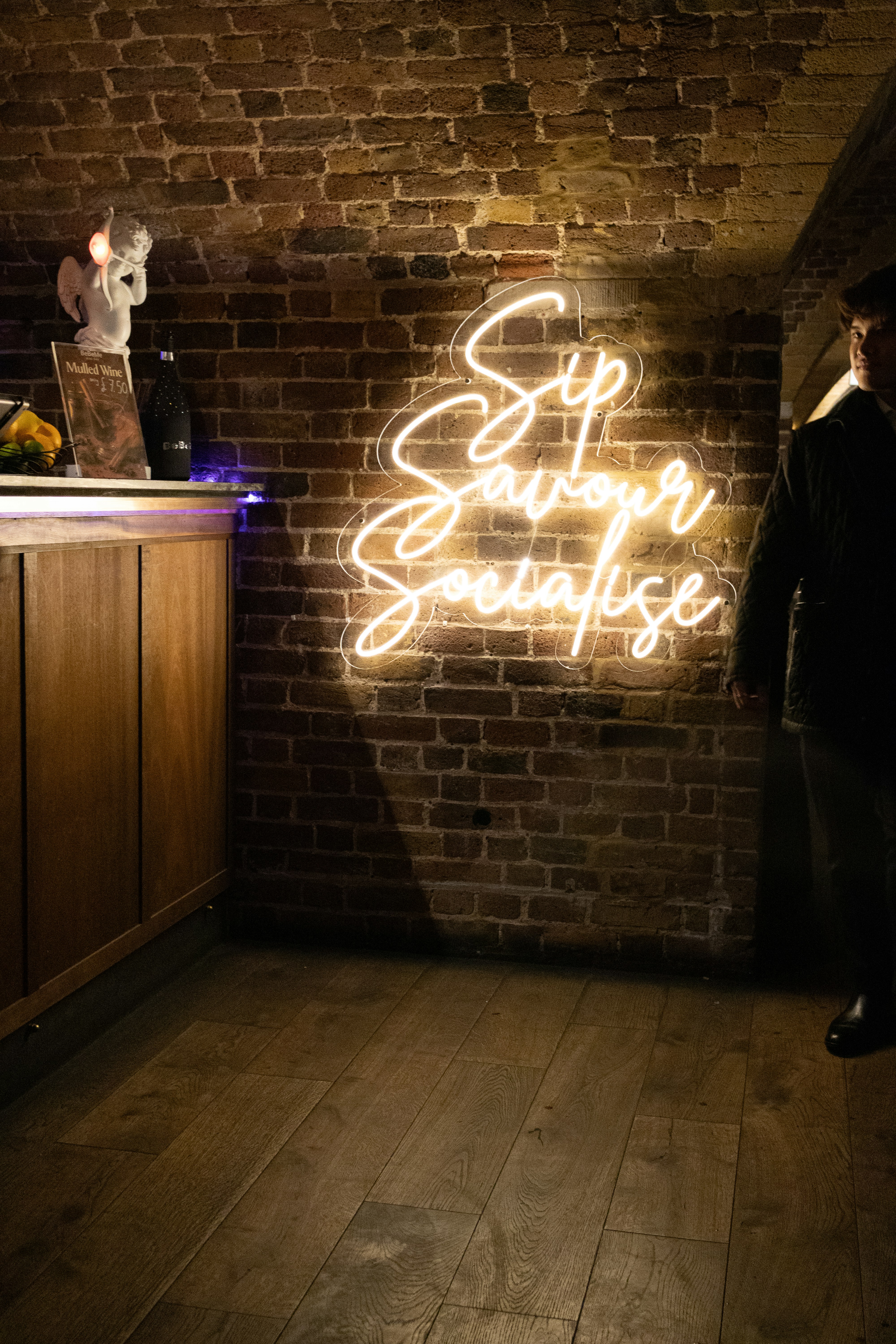 Neon Script on Brick: A Warm Glow by the Bar