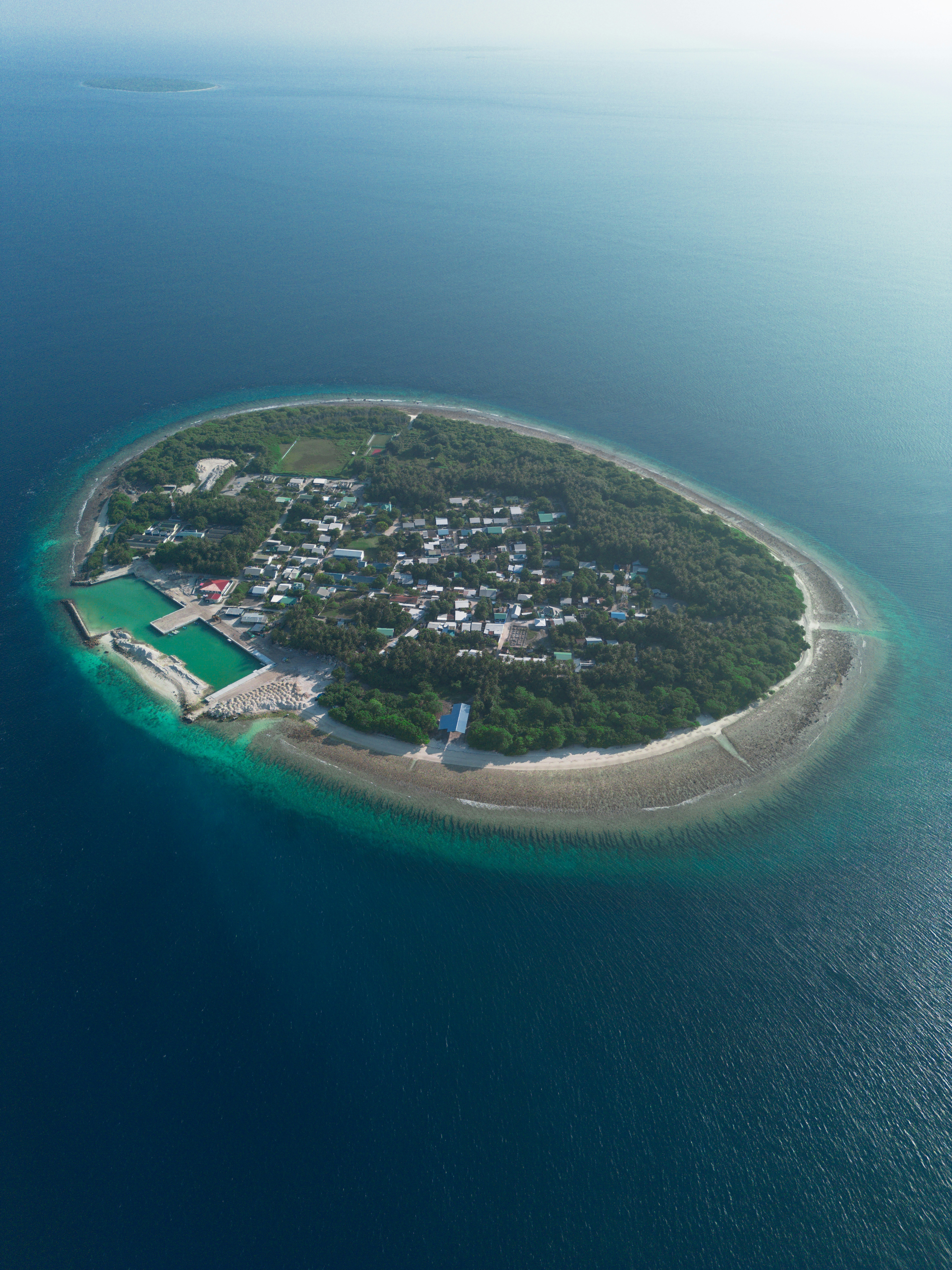 Aerial view of a small island village surrounded by ocean photo – Free ...