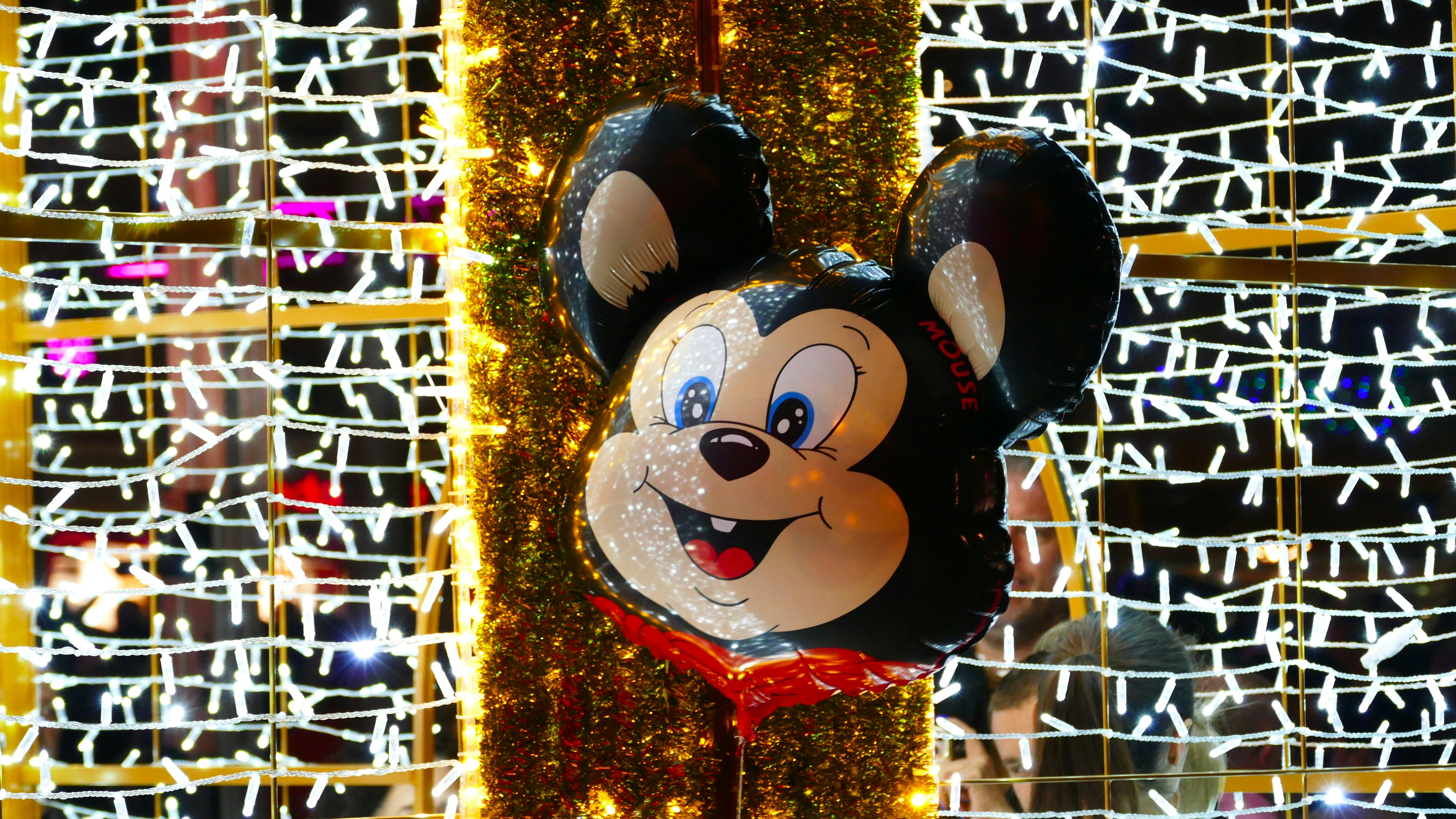 Glowing Mickey: A Balloon Beacon Amid Festive Lights