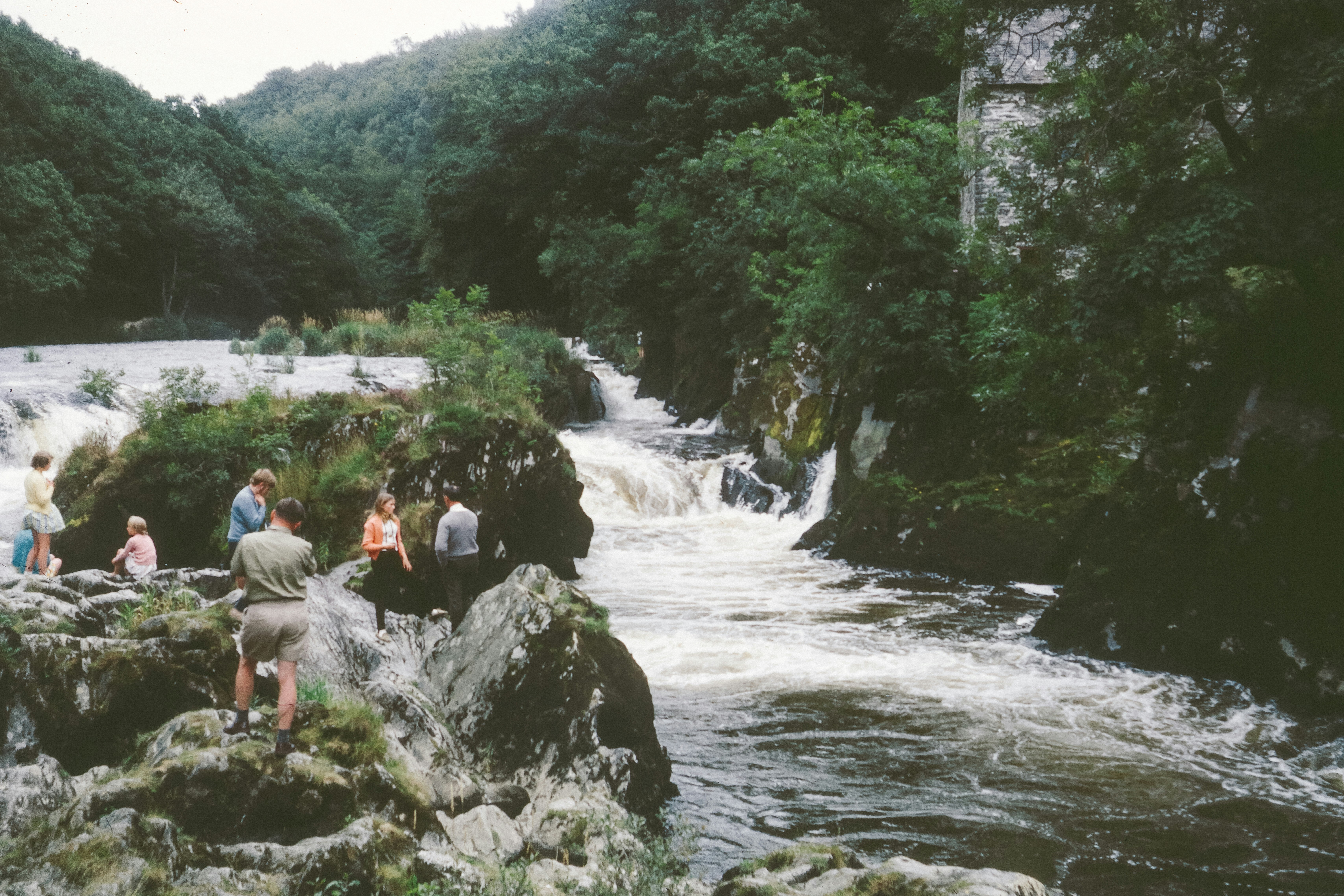 Rocky Riverbank Portraits: People explore a cascading gorge